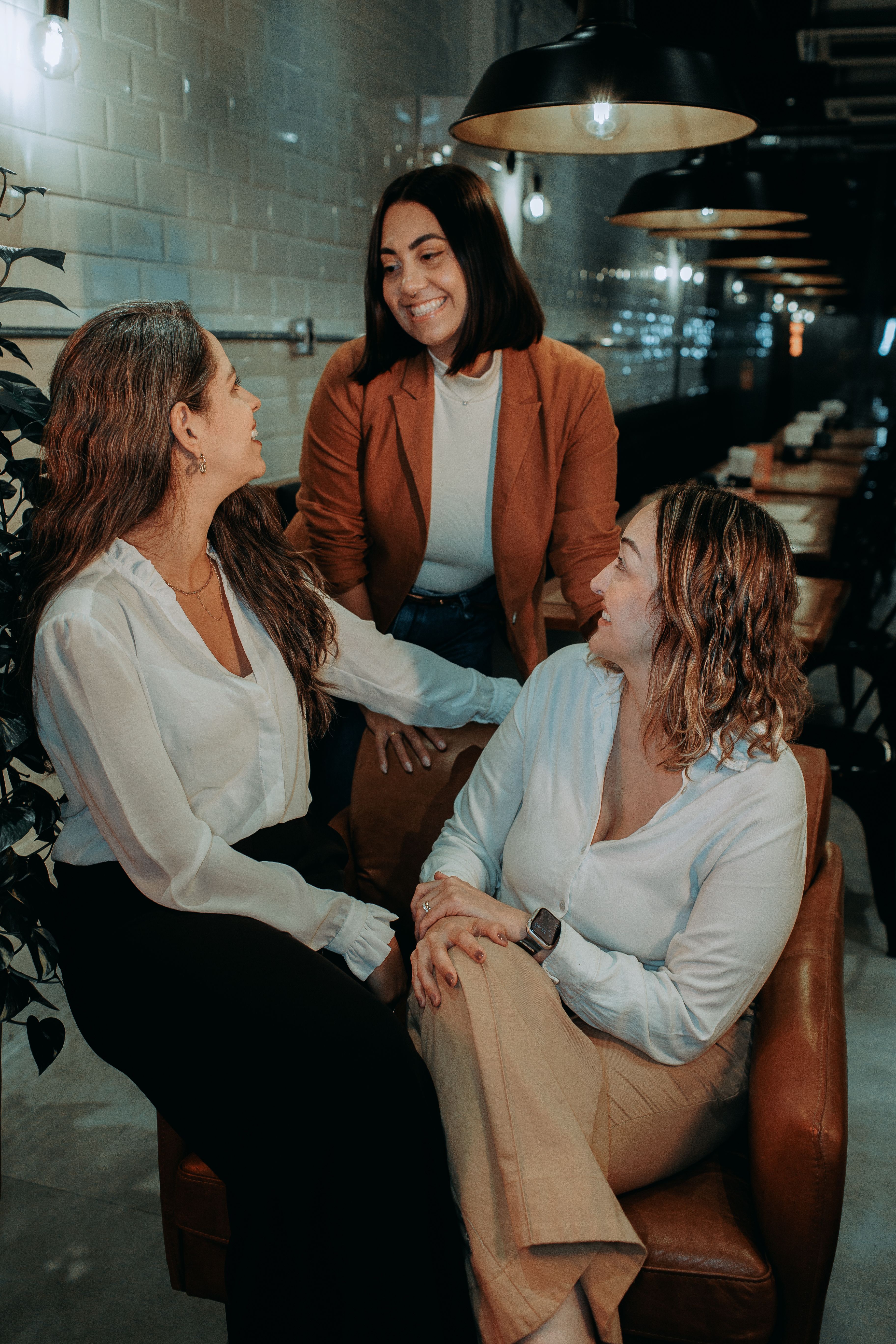 A Group of Elegant Women Sitting in a Restaurant · Free Stock Photo