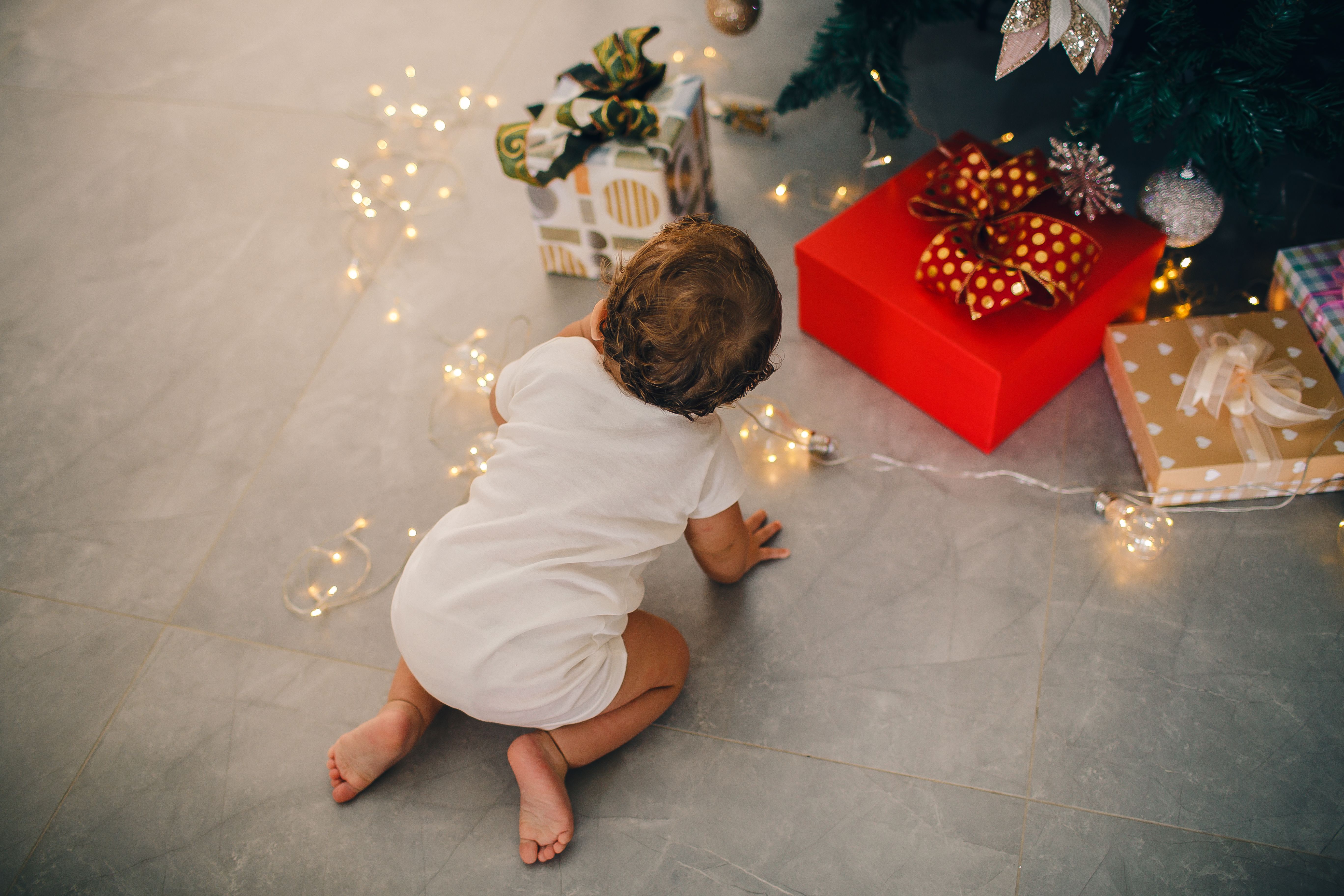 Baby Crawling Towards Christmas Tree and Gifts · Free Stock Photo