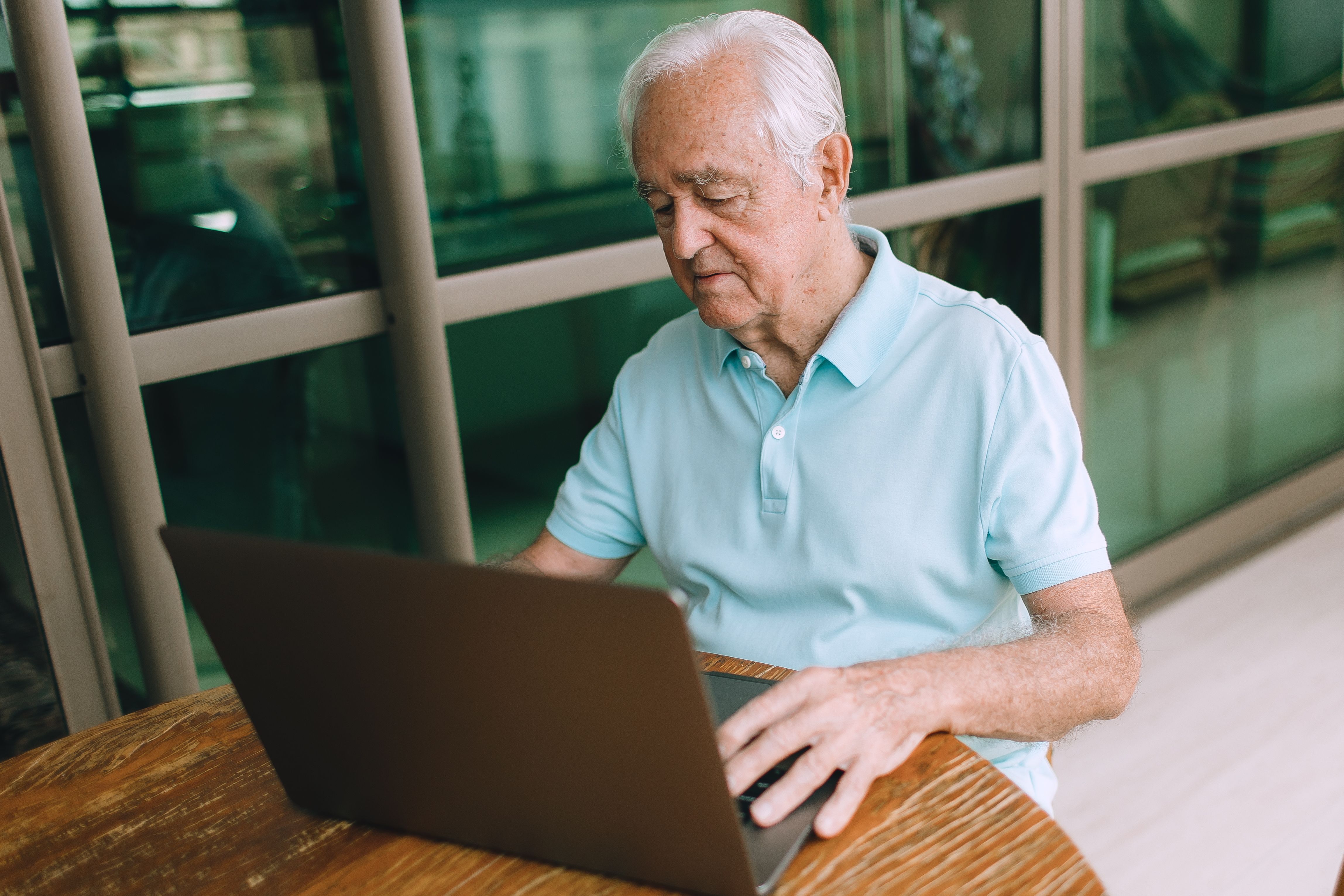 Sad Senior Man Sitting at Table with Laptop · Free Stock Photo