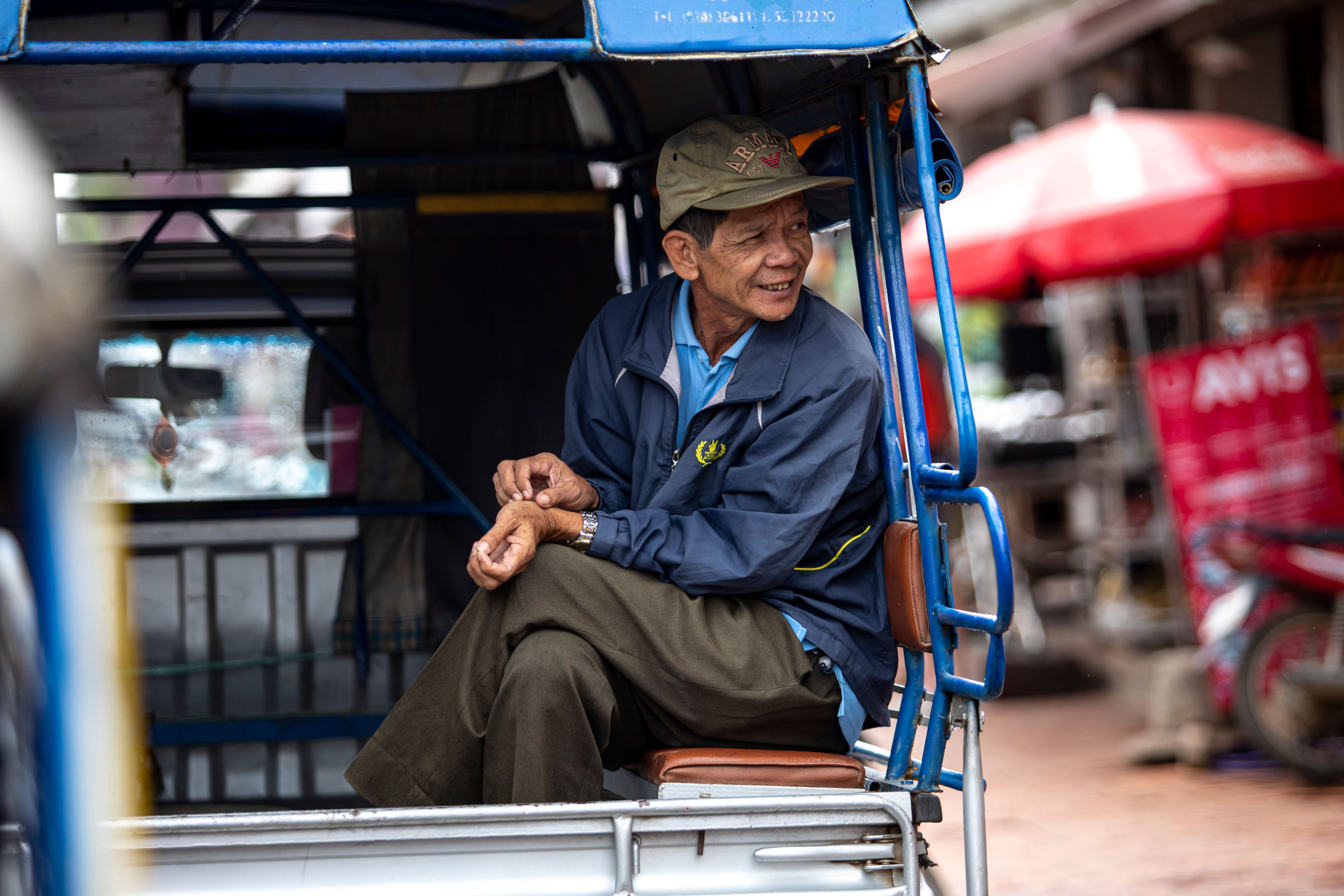 Candid Photo of a Man Sitting on the Back of a Truck · Free Stock Photo