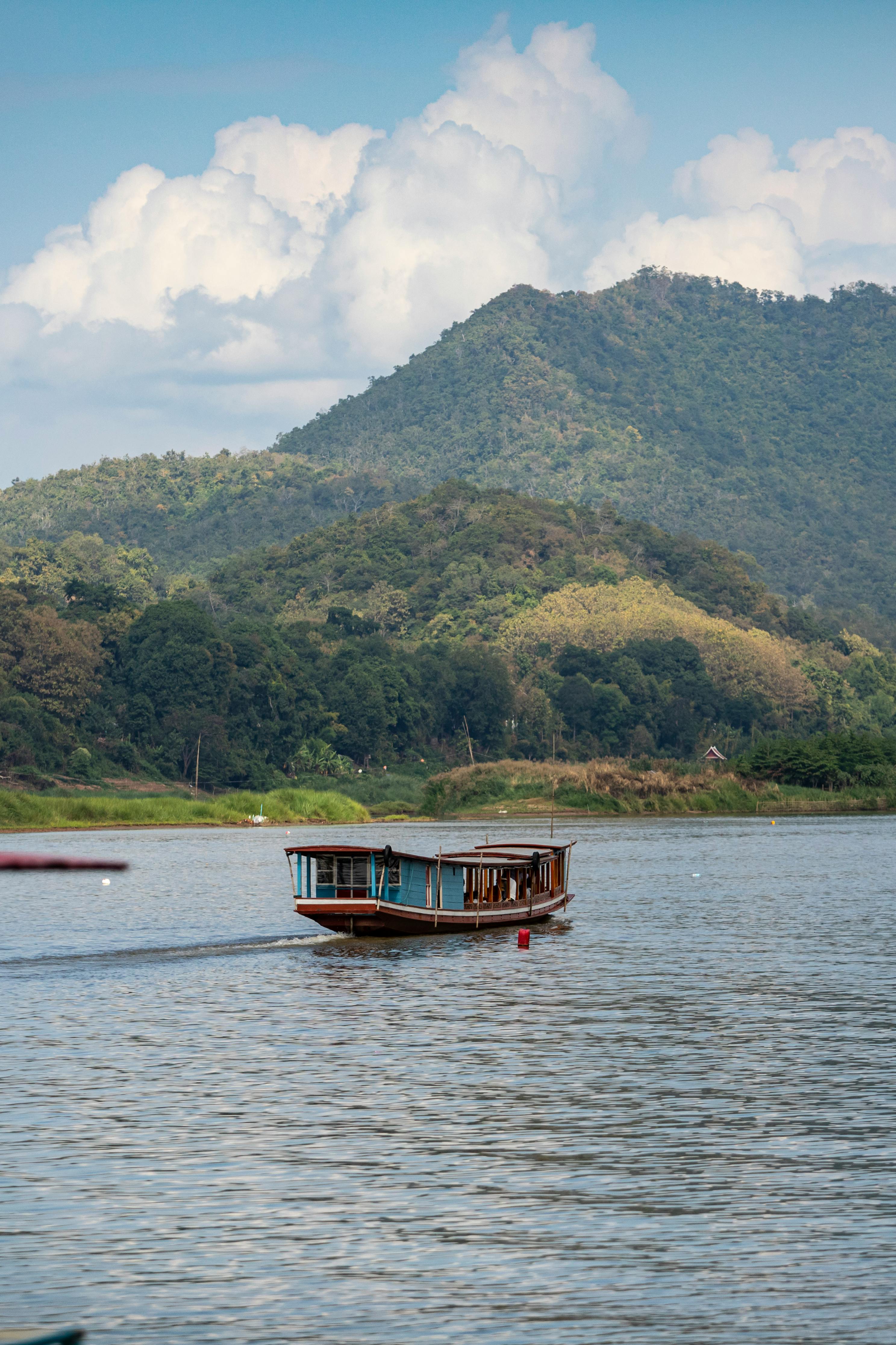 Small Traditional Wooden Ferry Boat Sailing on River in Laos · Free ...