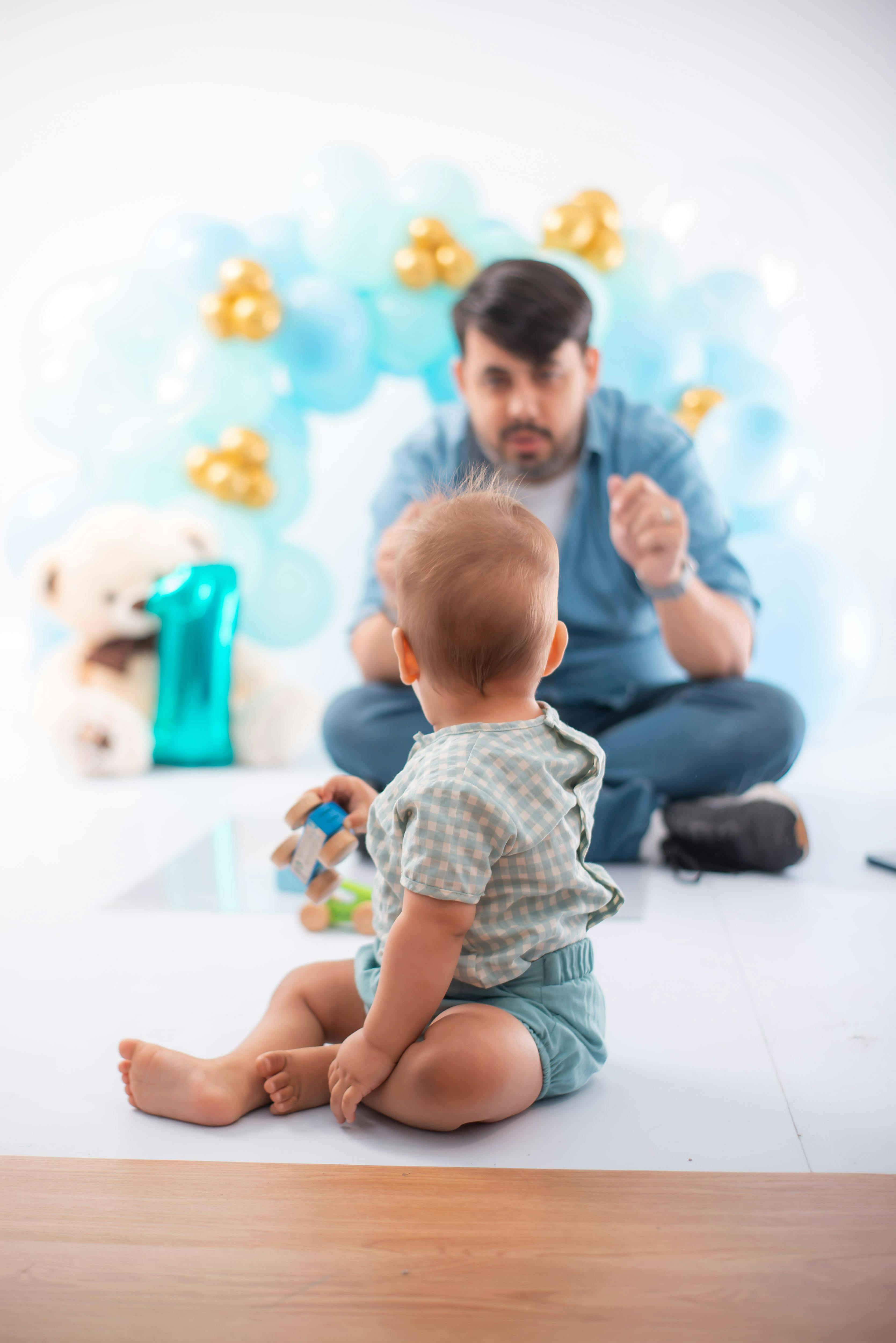 Baby Sitting and Looking Back at Father · Free Stock Photo