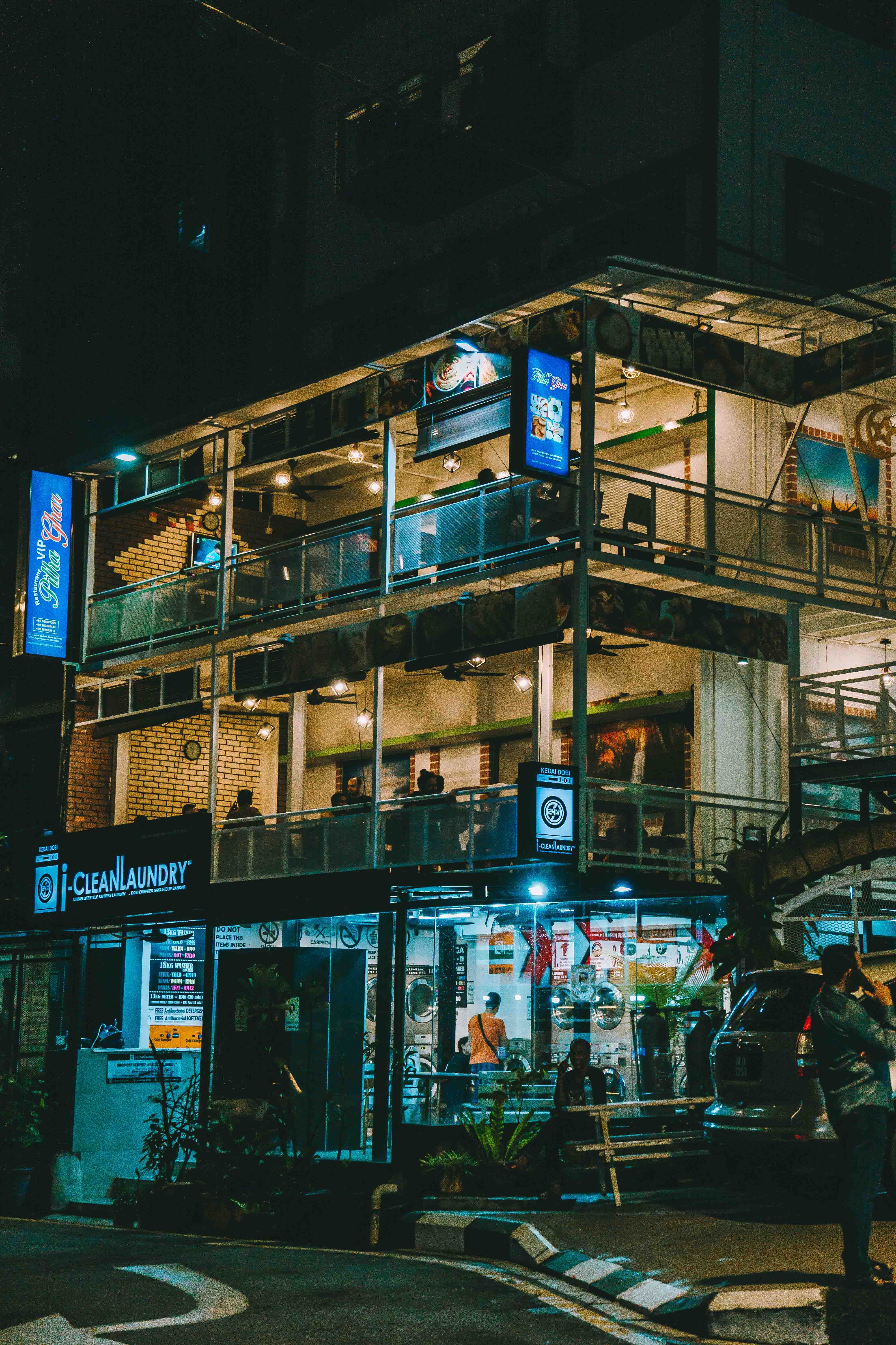Exterior of an Illuminated Laundromat at Night · Free Stock Photo