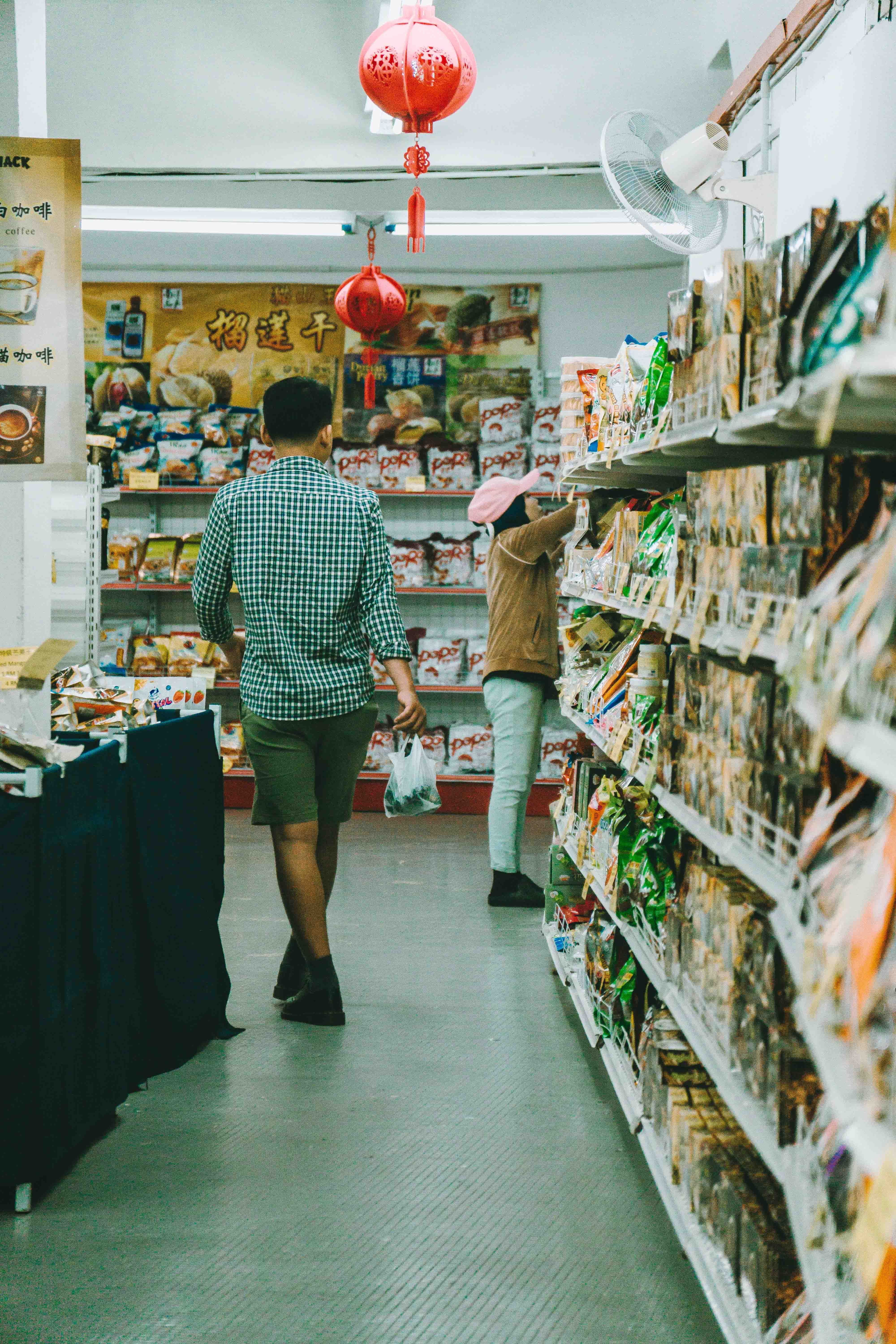 A Man Walking on a Grocery Store · Free Stock Photo