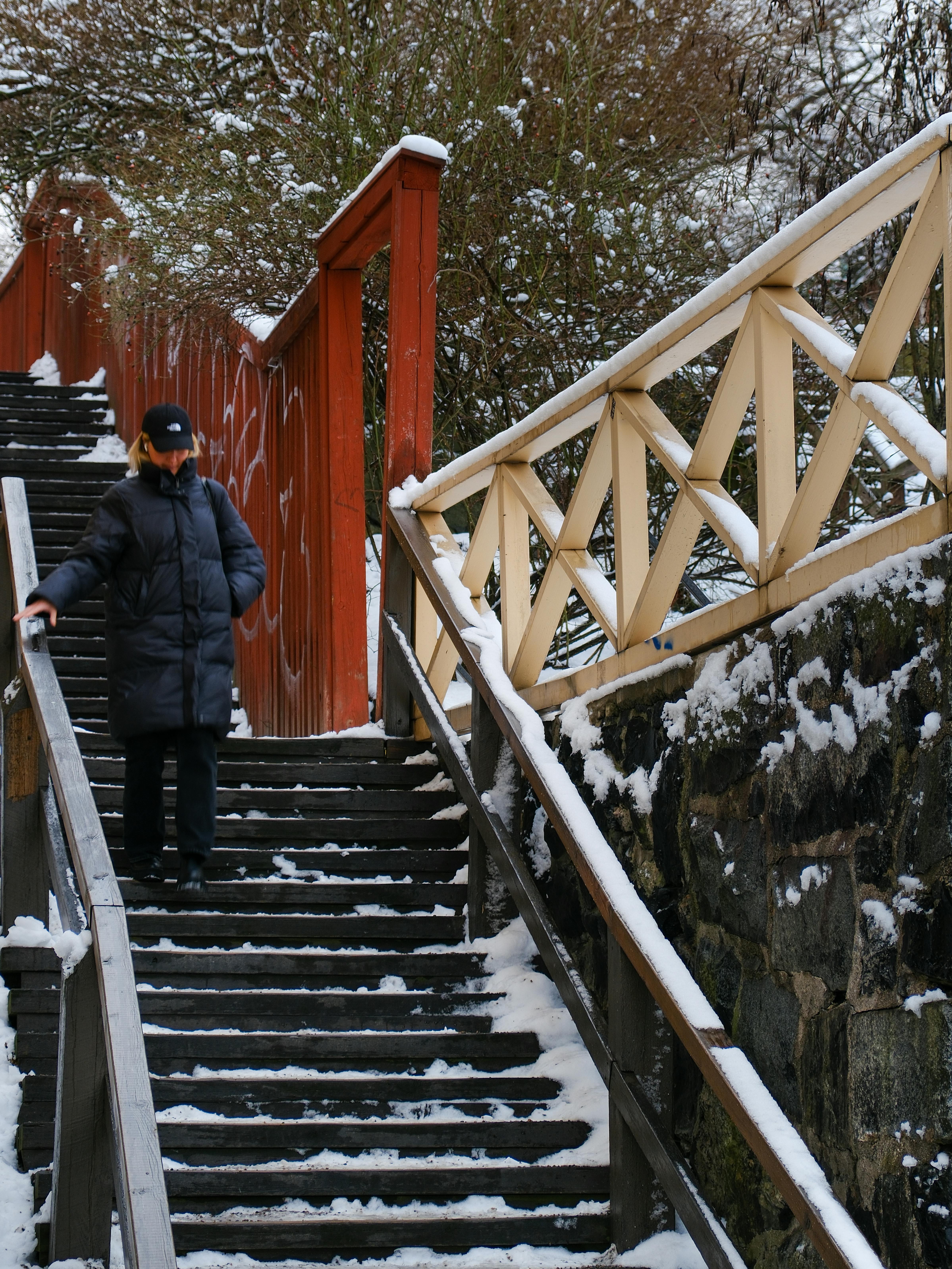 Woman Walking Down Snow-Covered Steps · Free Stock Photo