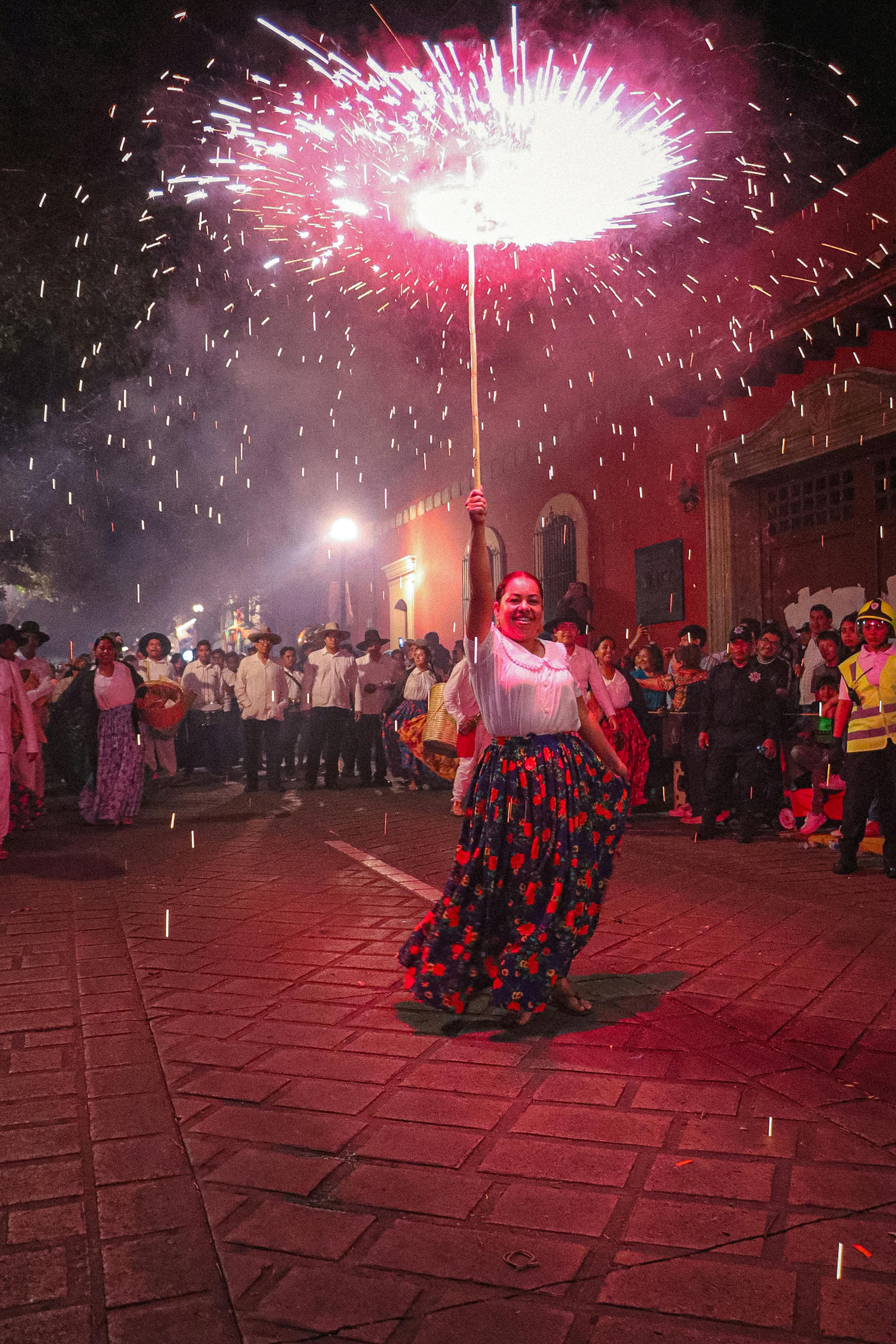 A Woman in a Costume Holding a Large Sparkler during a Festival · Free ...
