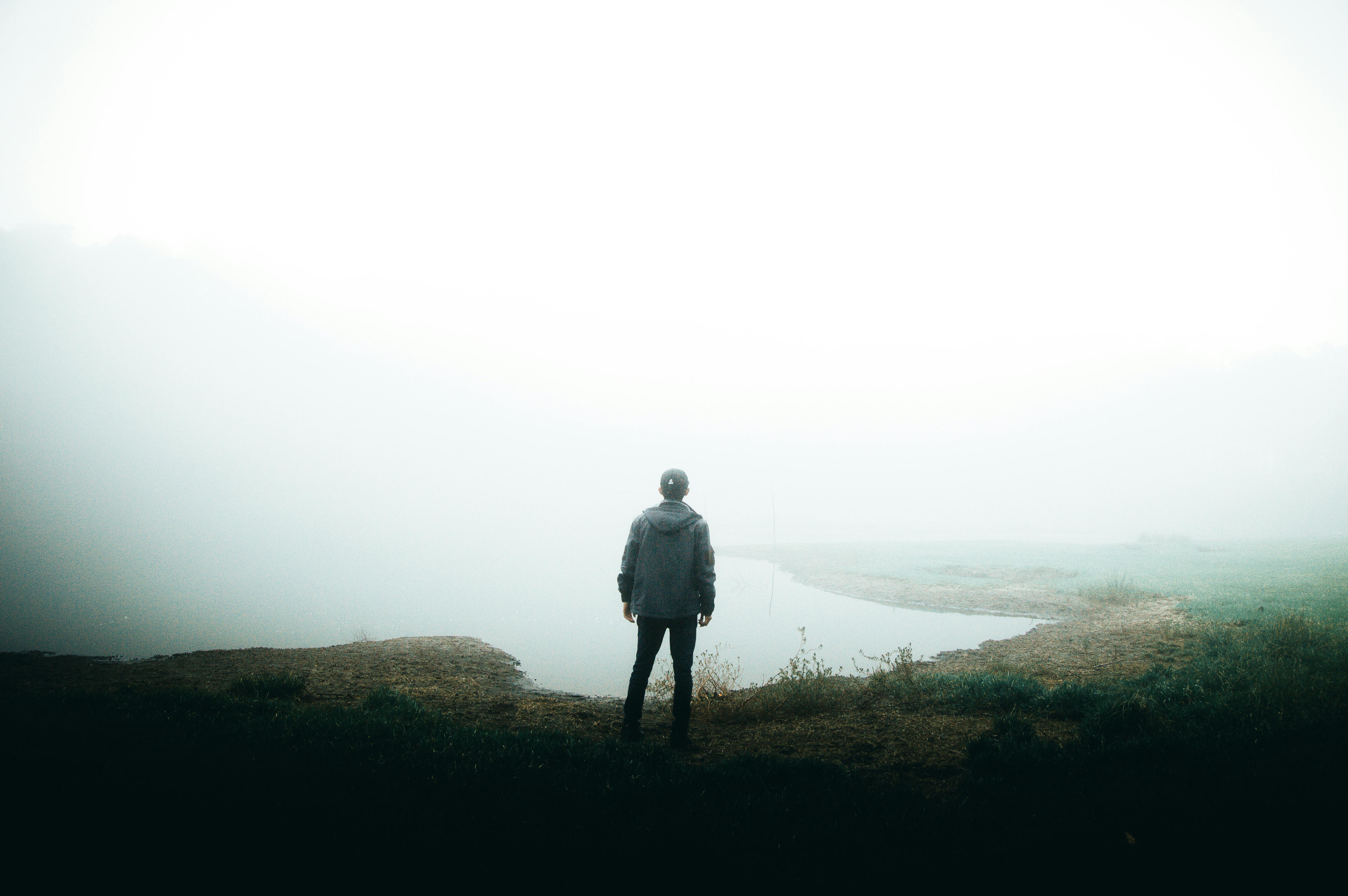 Fog over Man Standing near Lake in Countryside · Free Stock Photo
