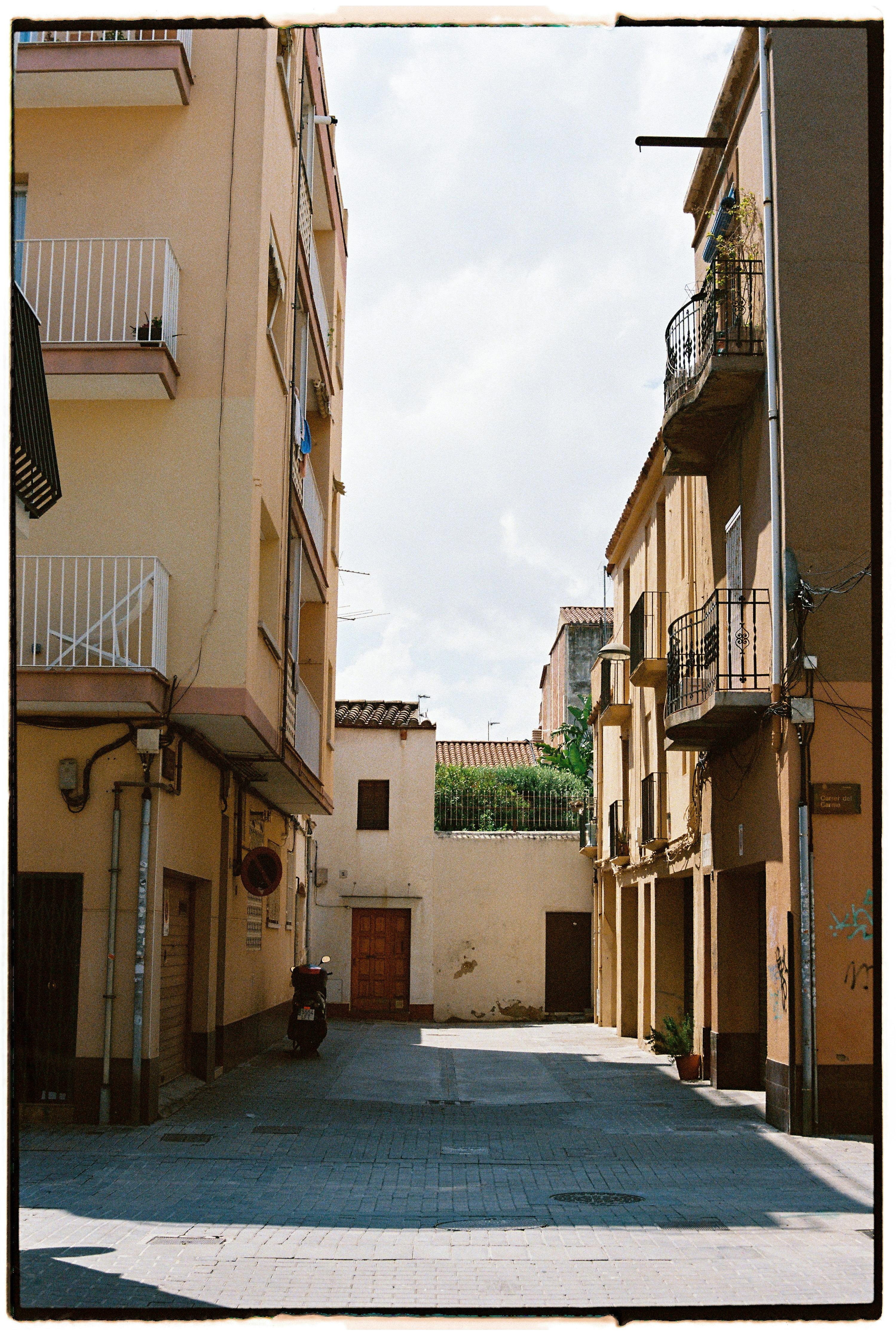 Narrow Parking Lot between Apartment Buildings · Free Stock Photo