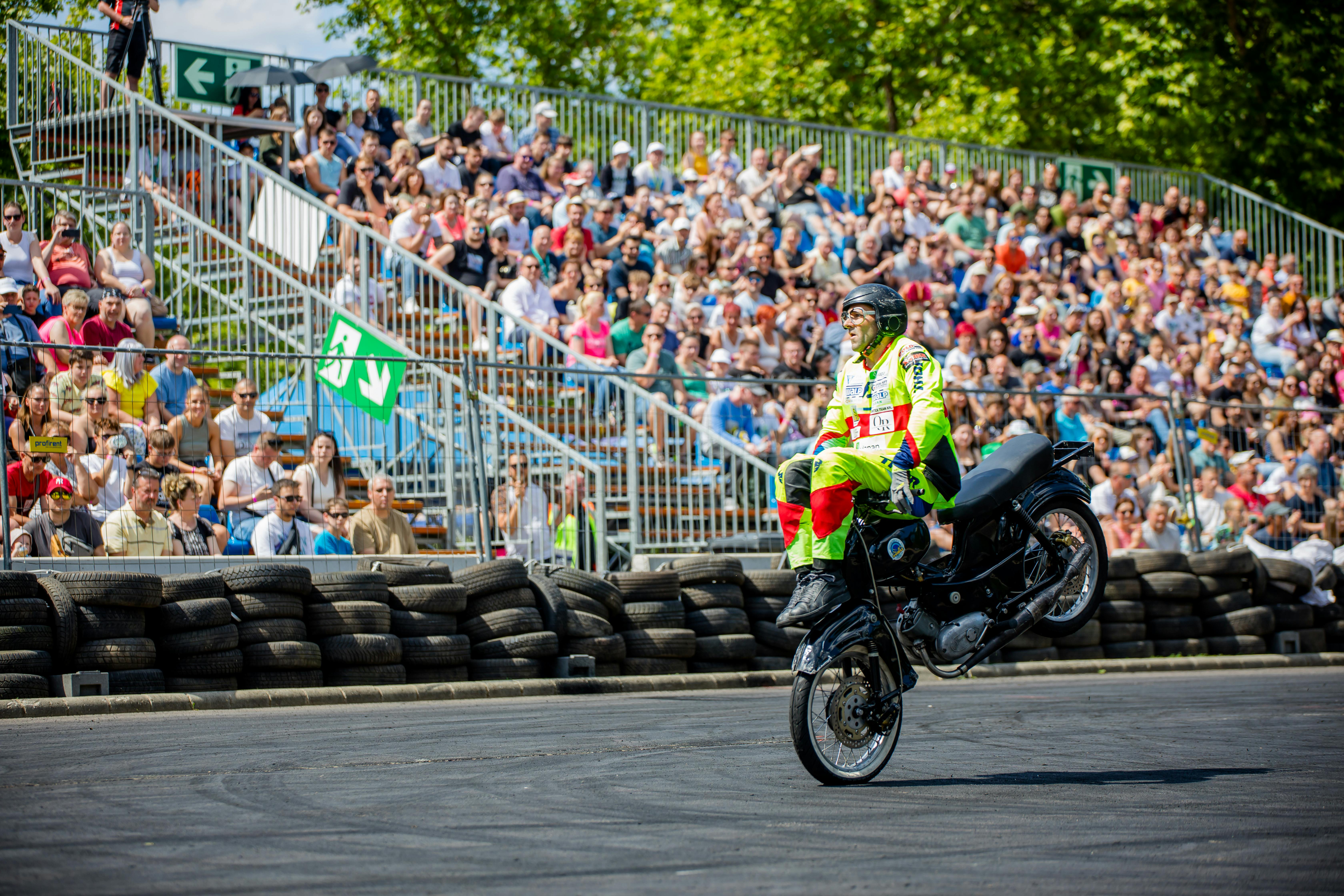 People Watching a Man Do a Motorcycle Stunt · Free Stock Photo