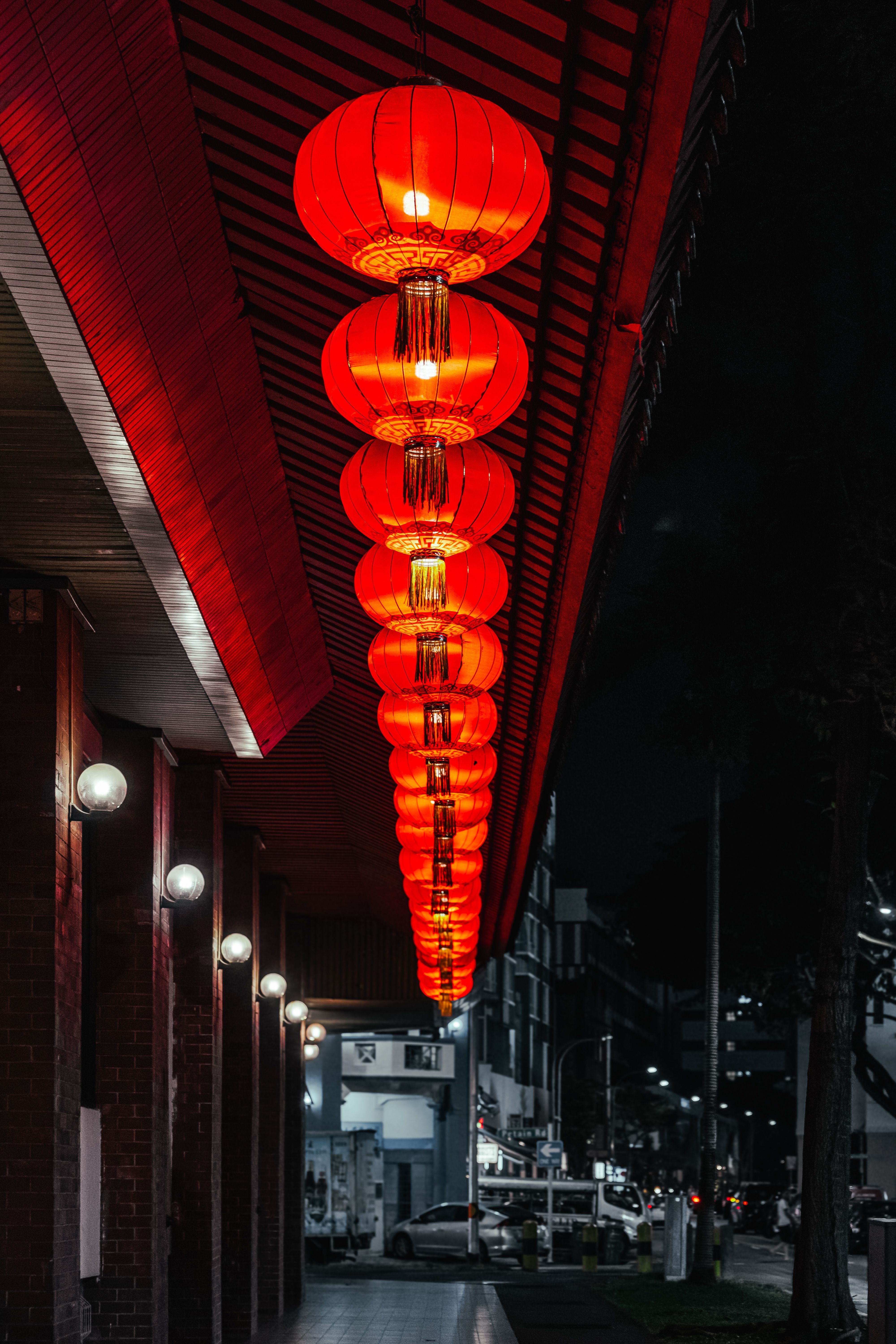 Traditional Lanterns on Building Wall at Night · Free Stock Photo