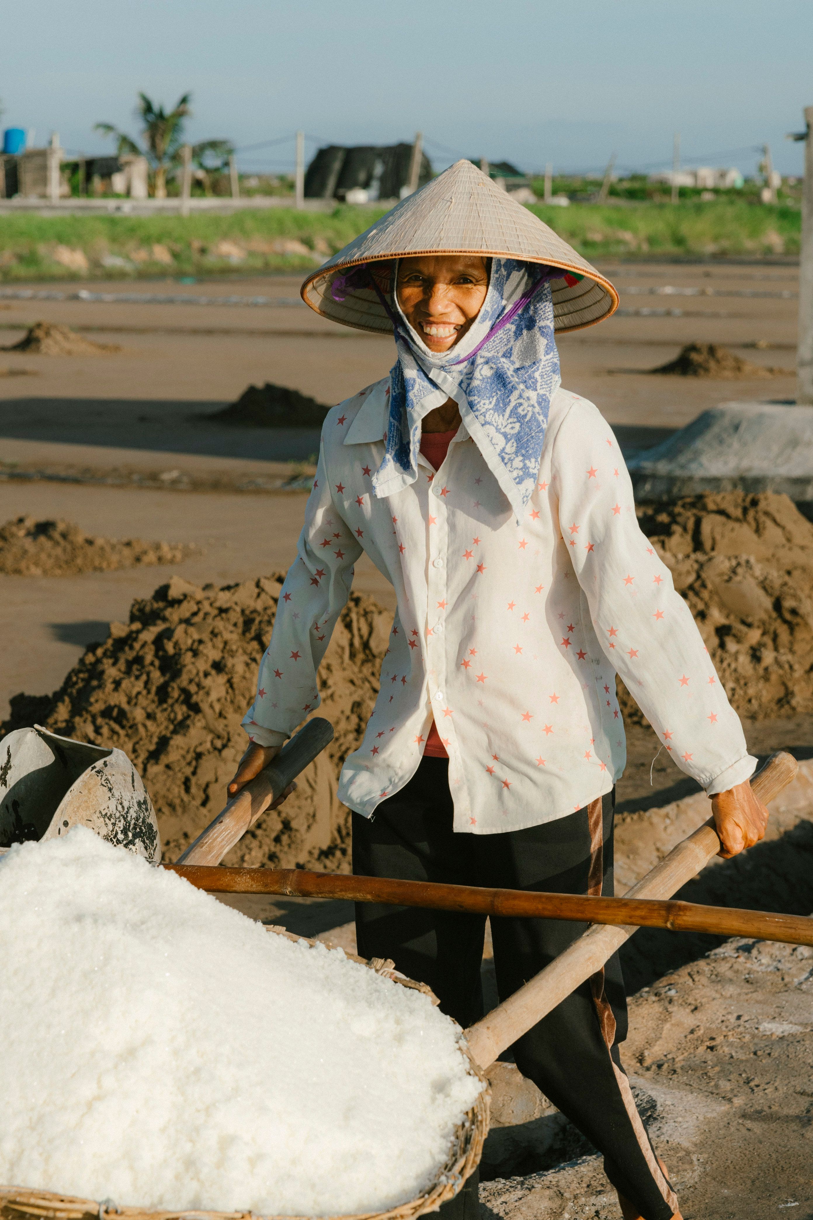 A Smiling Woman Holding the Handles of a Wheelbarrow Full of Salt ...
