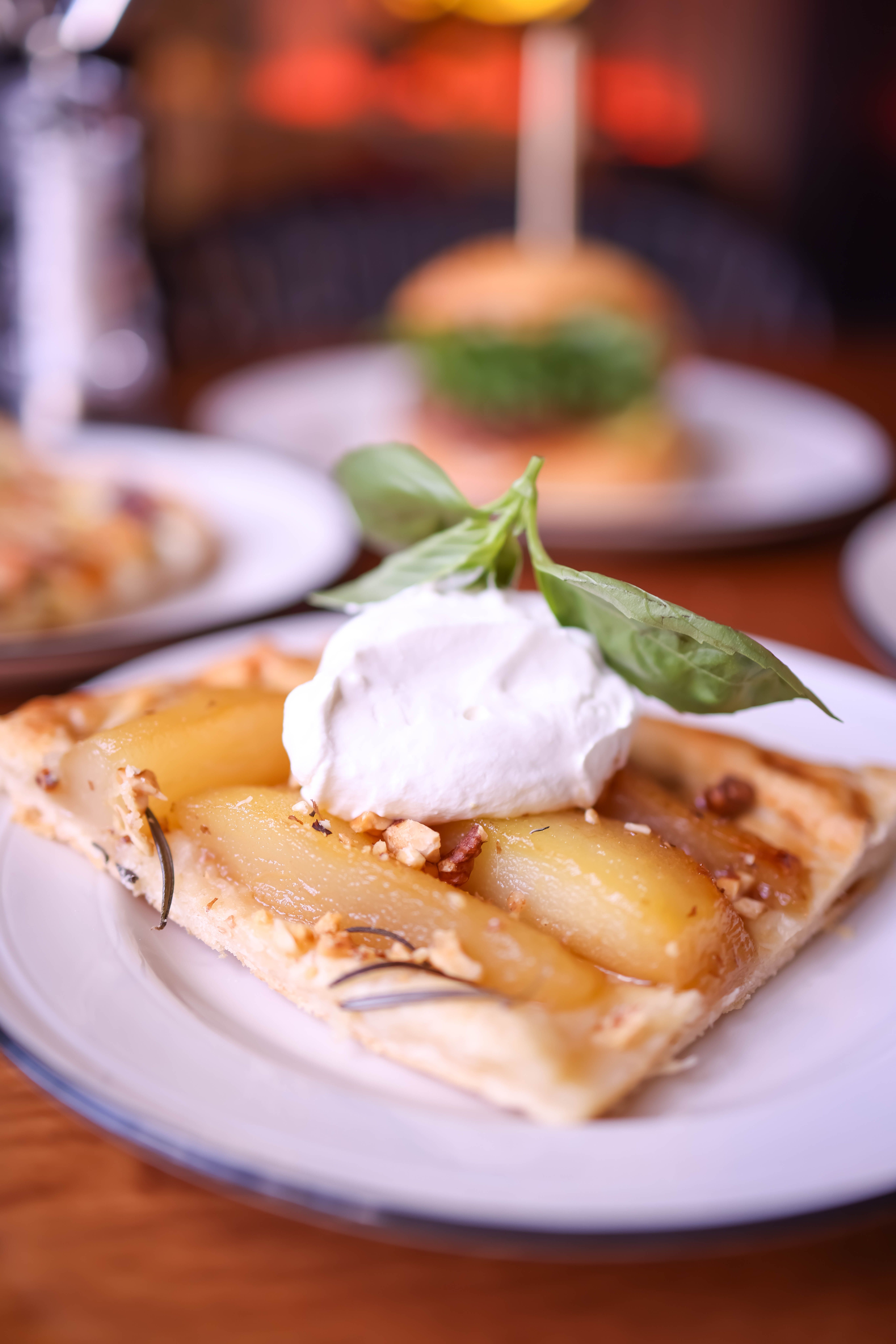 A slice of pizza with whipped cream and a garnish · Free Stock Photo