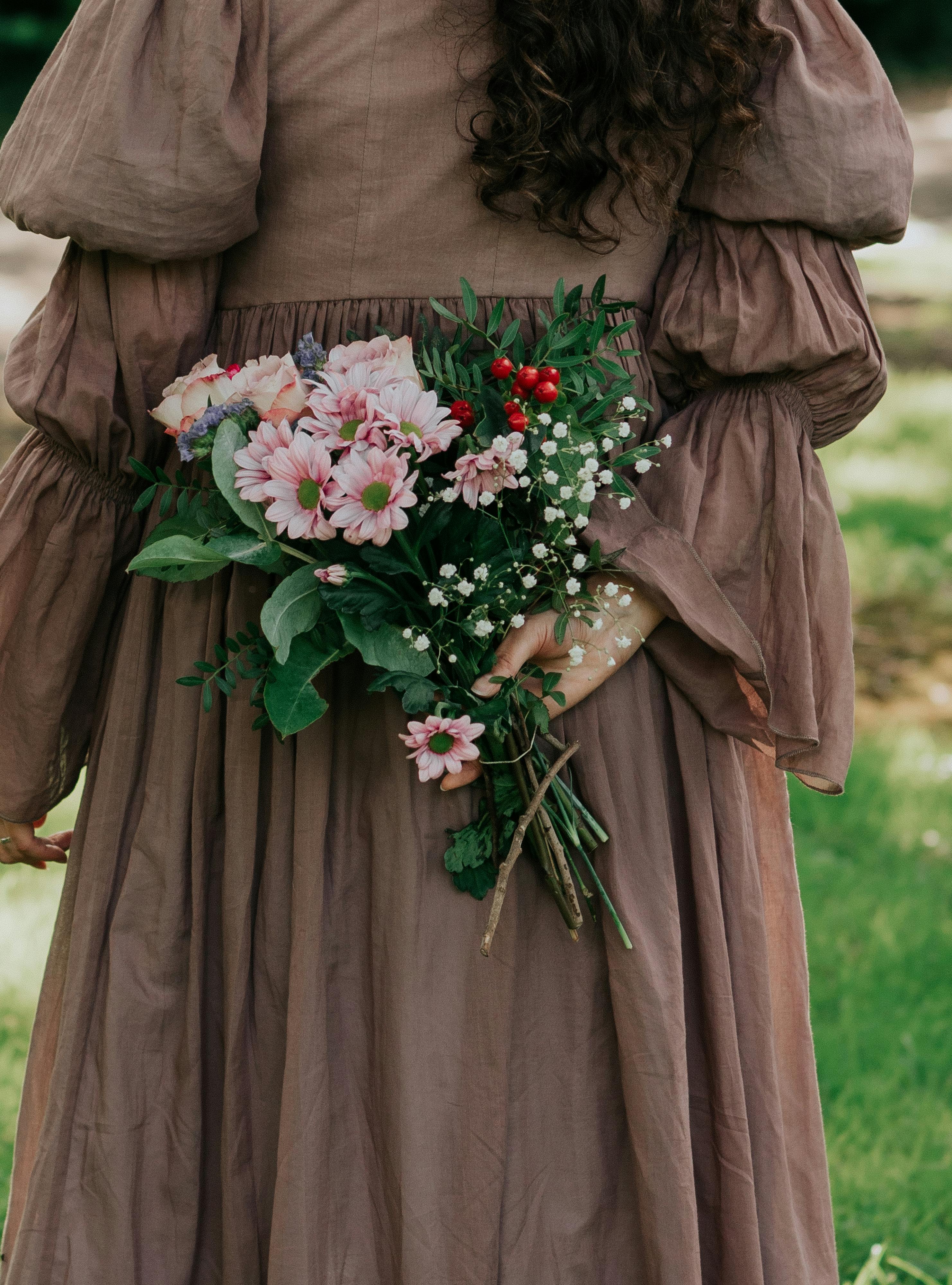 Woman Sitting on Tree While Holding Bouquet of White Flower · Free ...