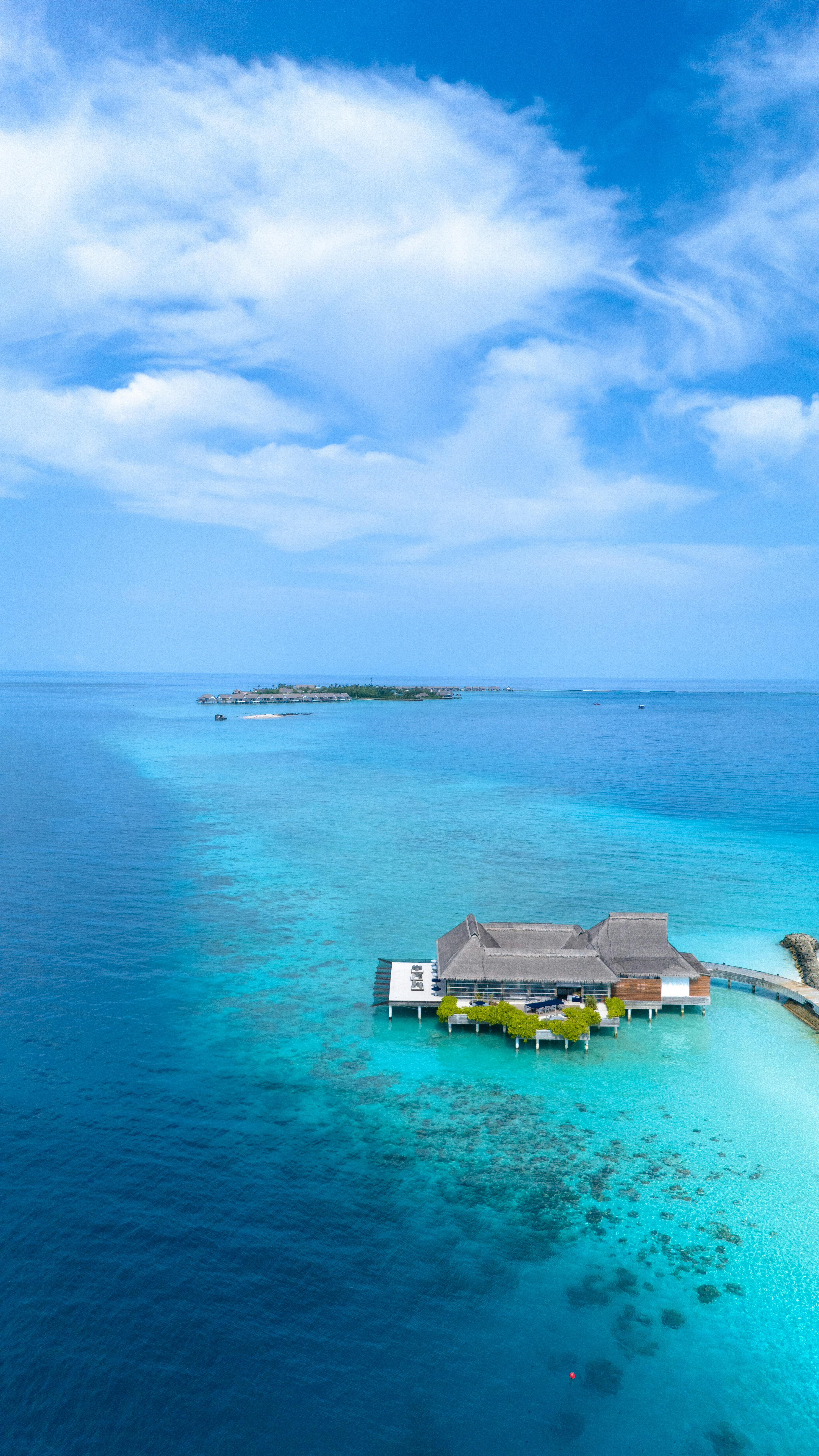 An aerial view of a small island with a small house on it · Free Stock ...