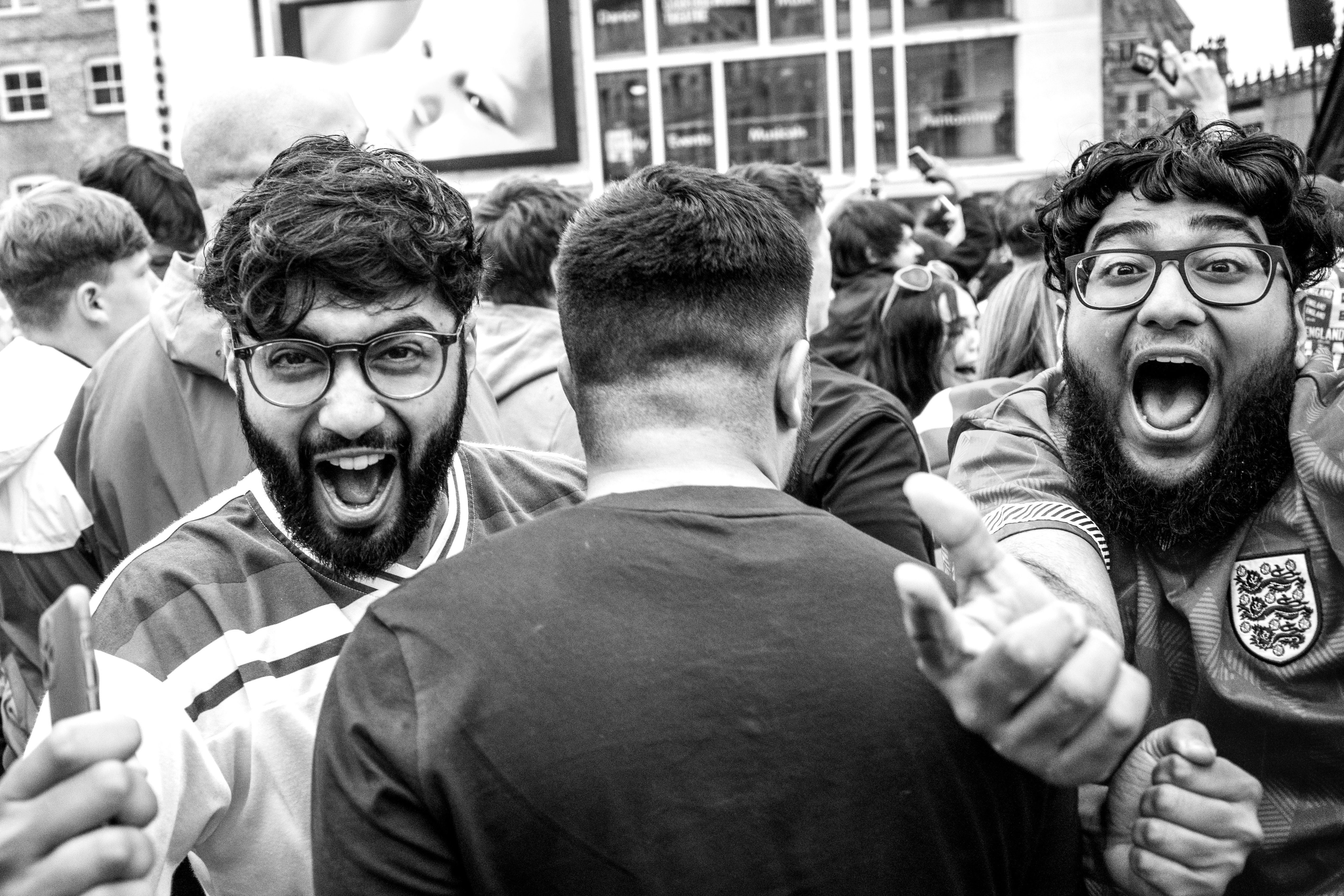 A group of men are celebrating in a crowd · Free Stock Photo