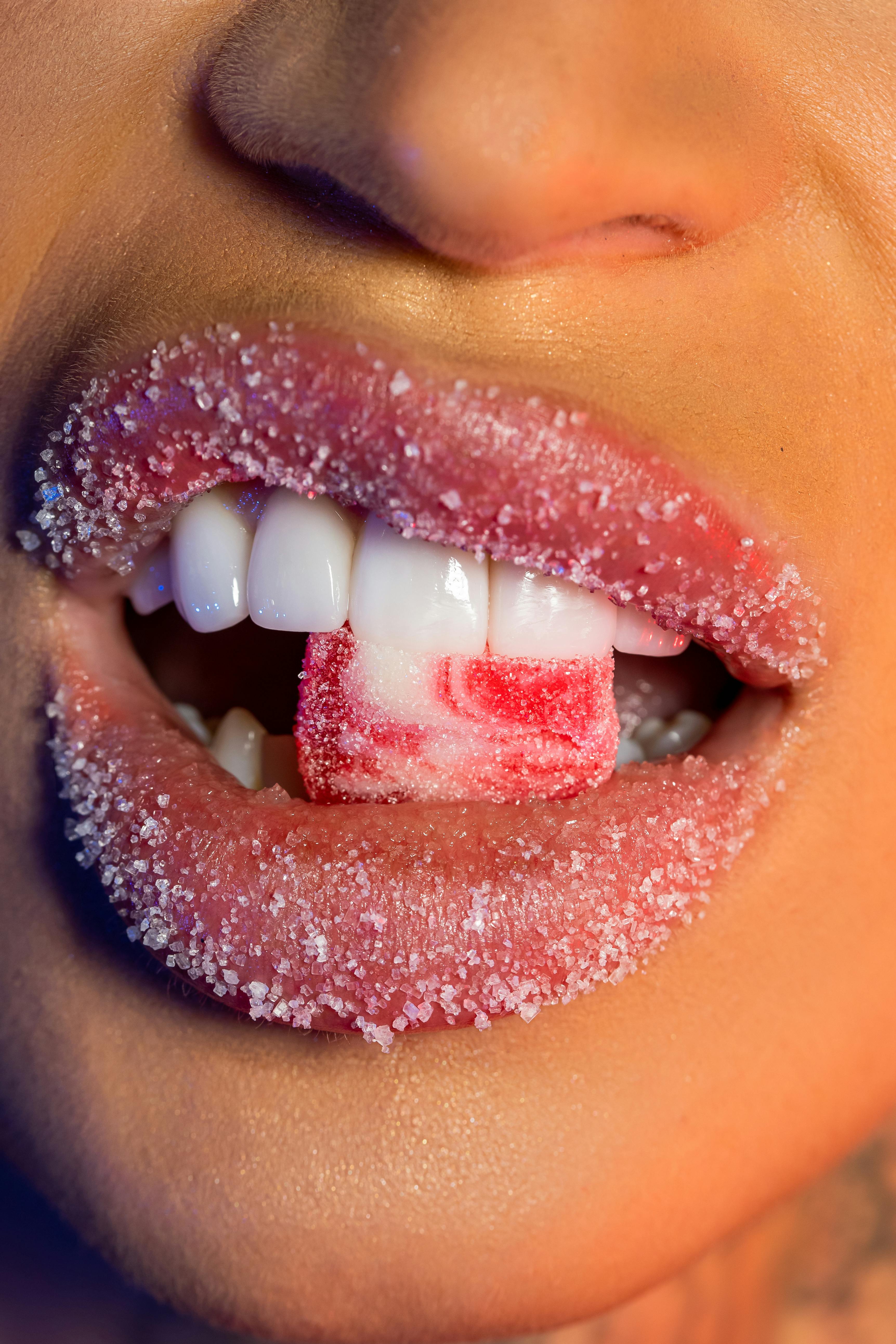 Lips of Woman Eating Jellybean · Free Stock Photo