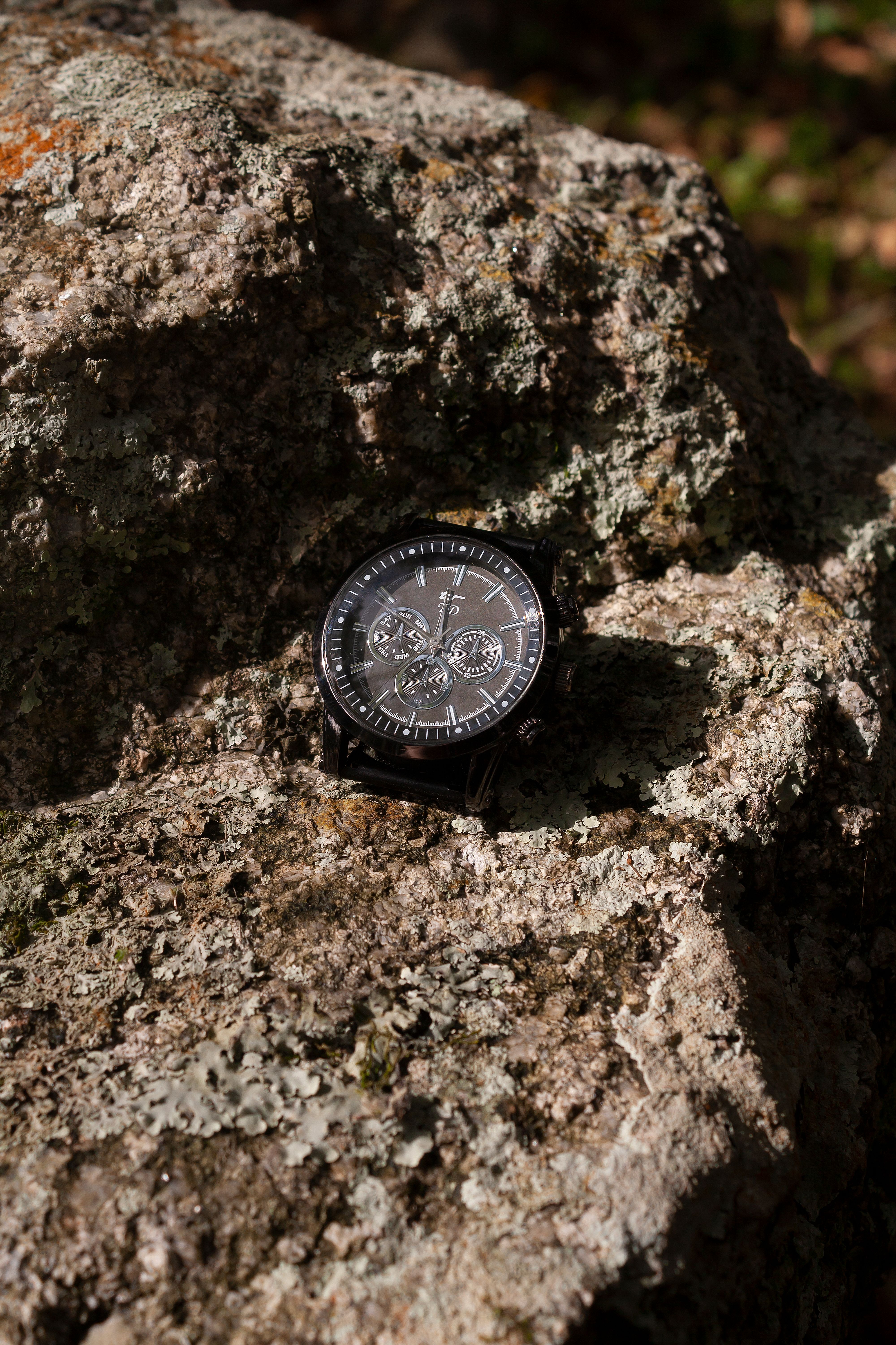A watch sitting on top of a rock · Free Stock Photo