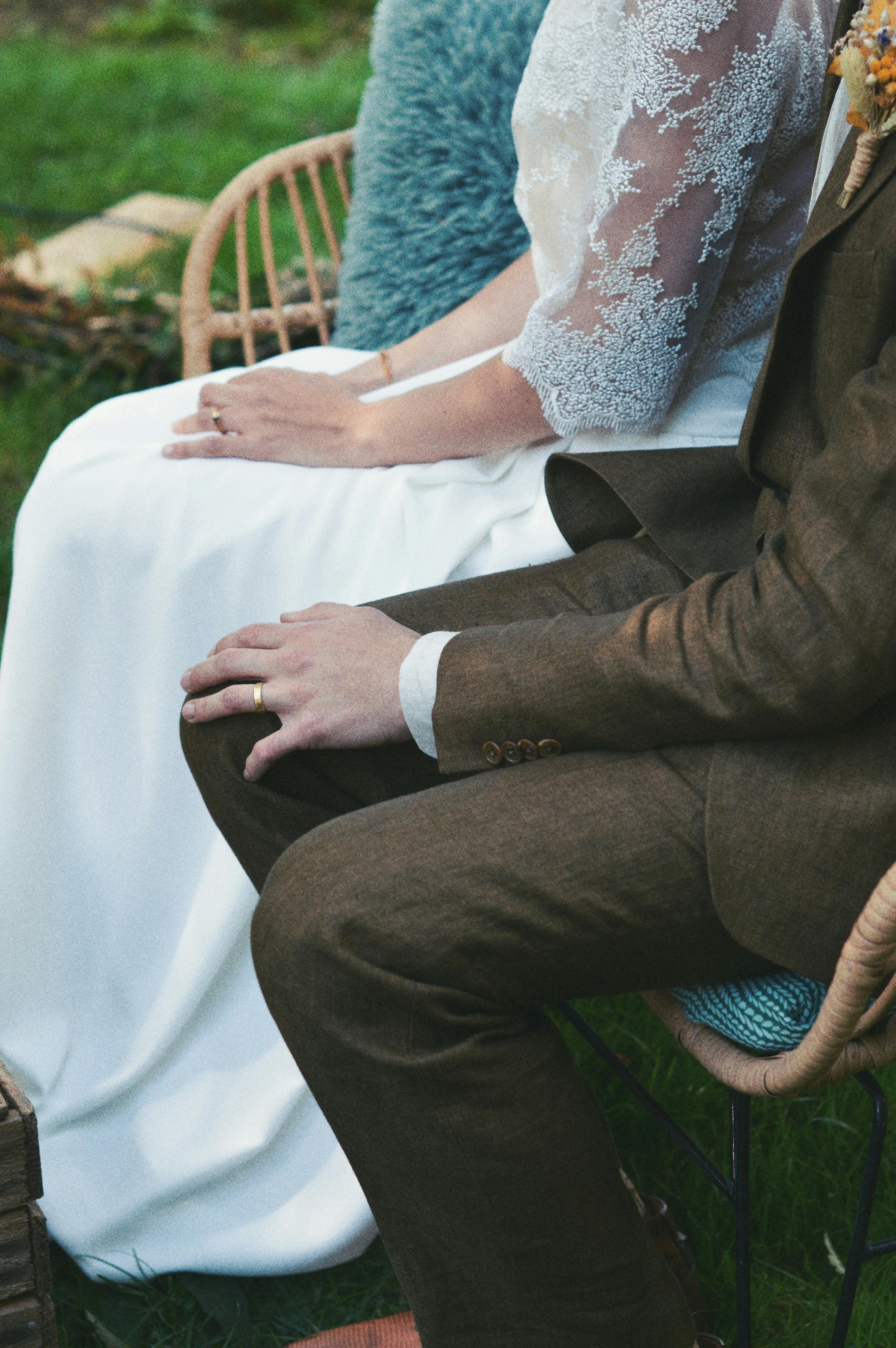 Bride and Groom Sitting on a Bench Outside · Free Stock Photo