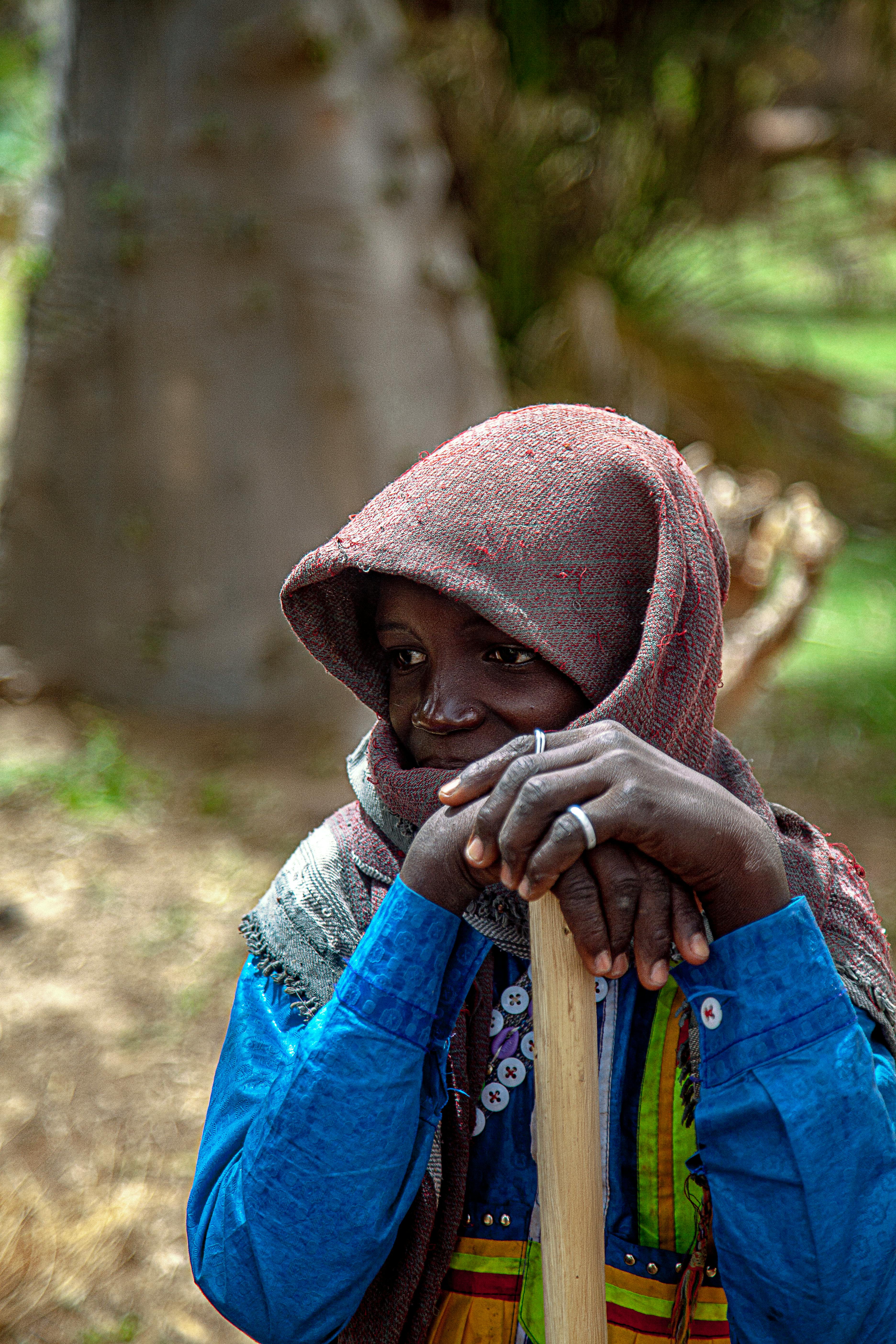 A young girl with a stick in her hand · Free Stock Photo