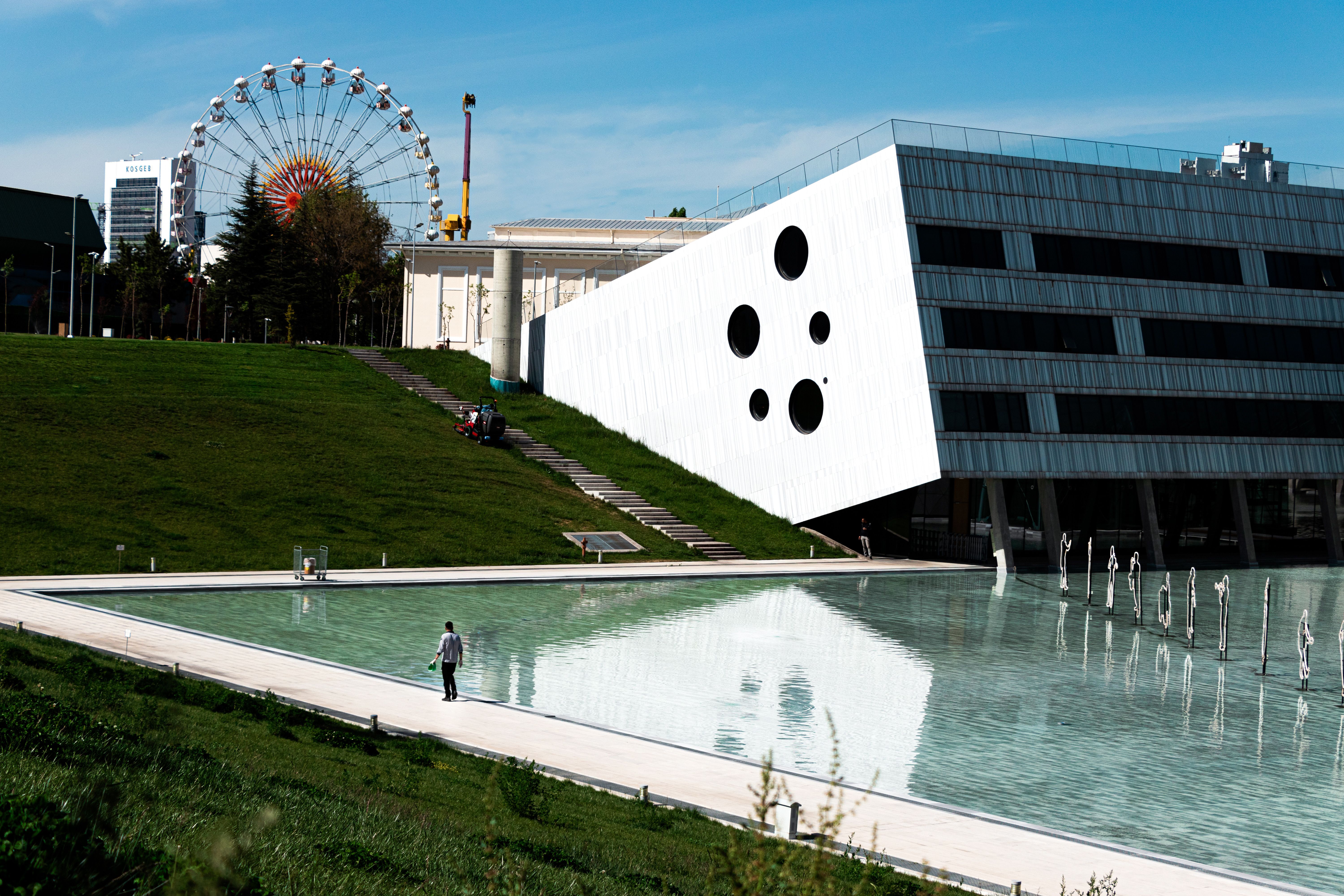 A building with a large white building and a ferris wheel · Free Stock ...