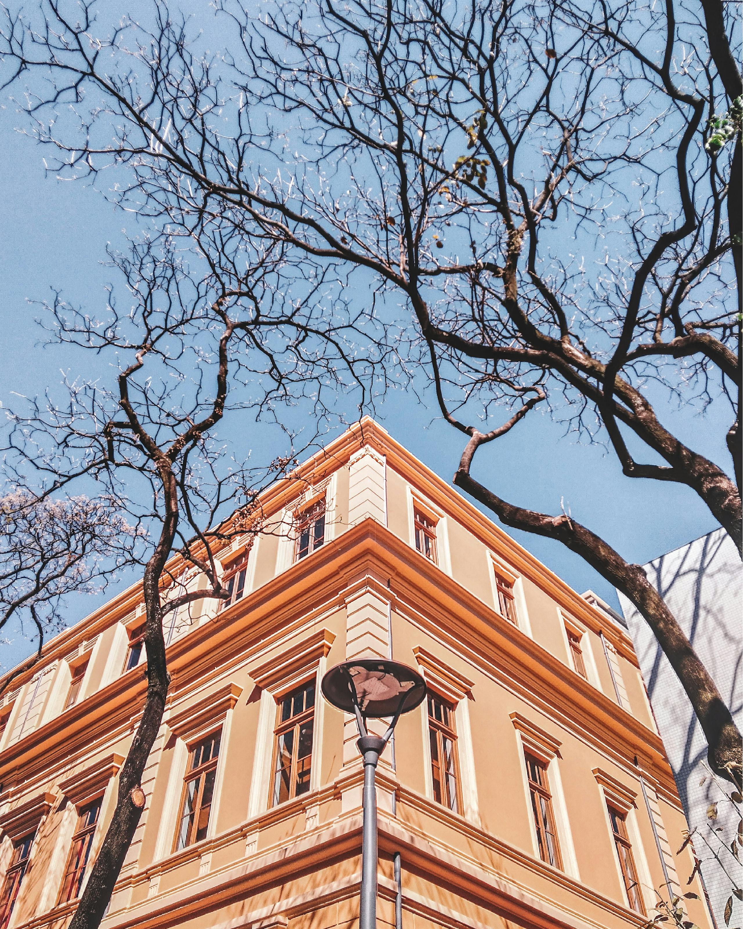 Low Angle Photography Of A Beige Building · Free Stock Photo