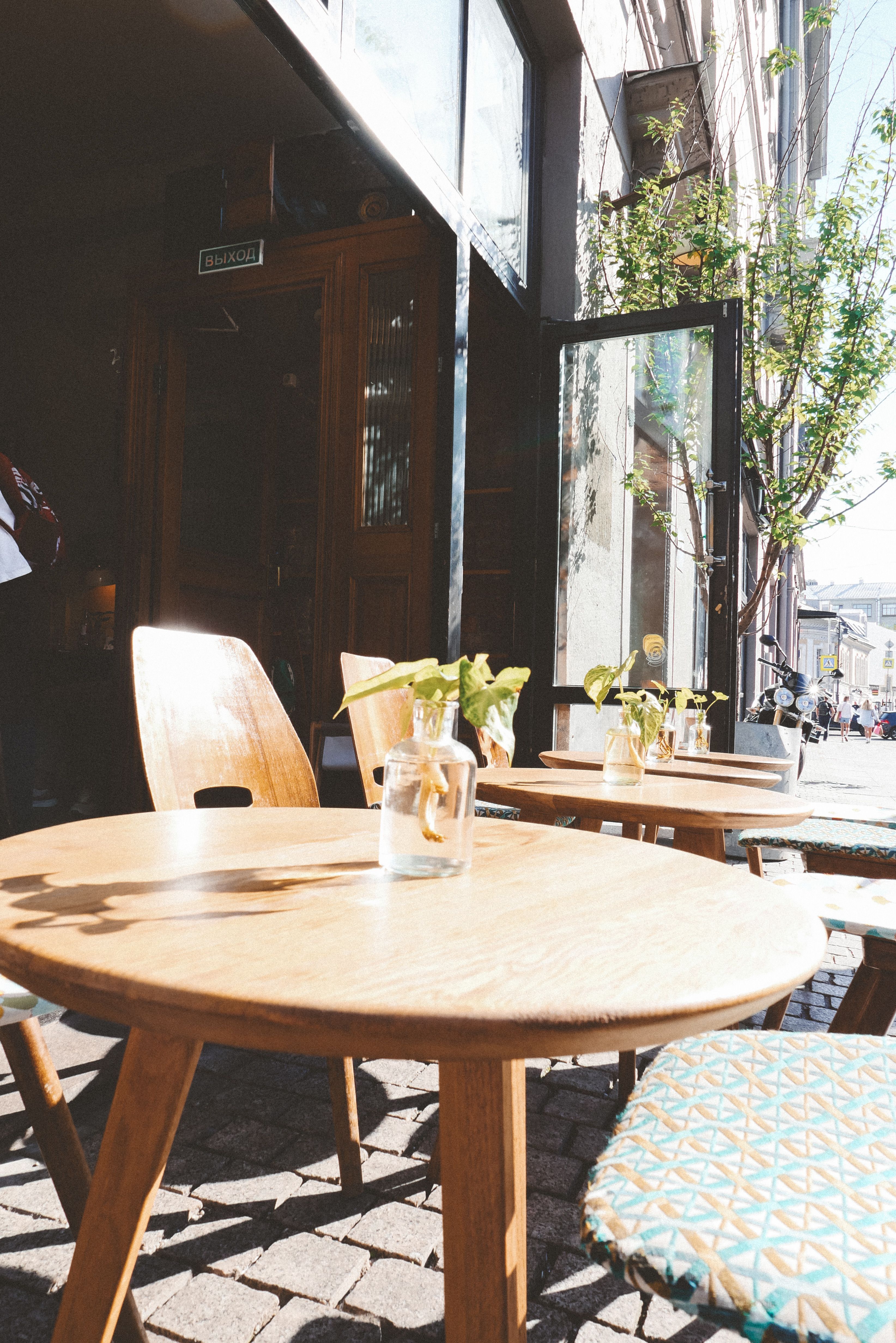 Sun Shining on the Tables Standing on the Sidewalk Outside of a ...