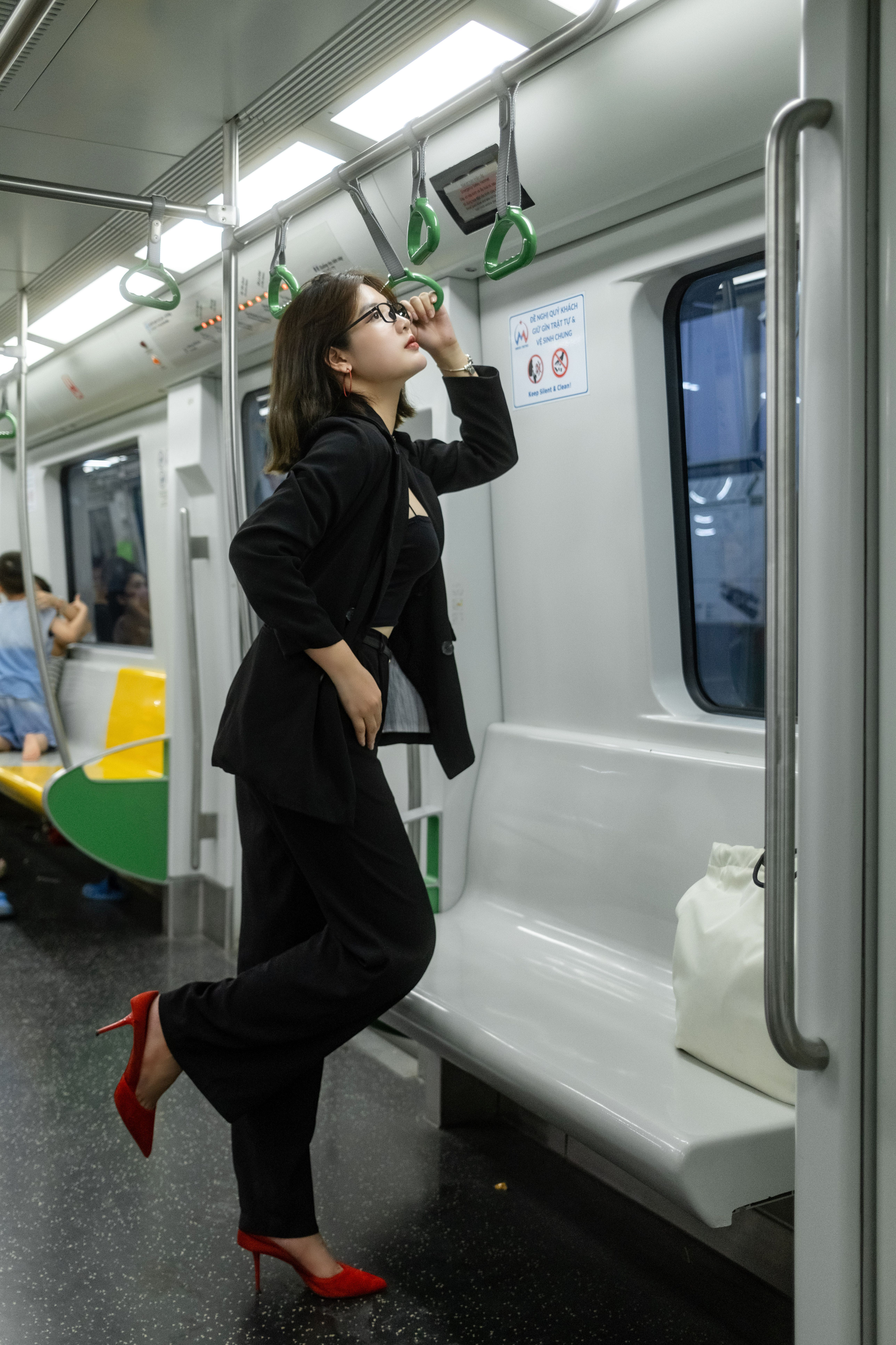 An Elegant Woman Standing in a Subway · Free Stock Photo