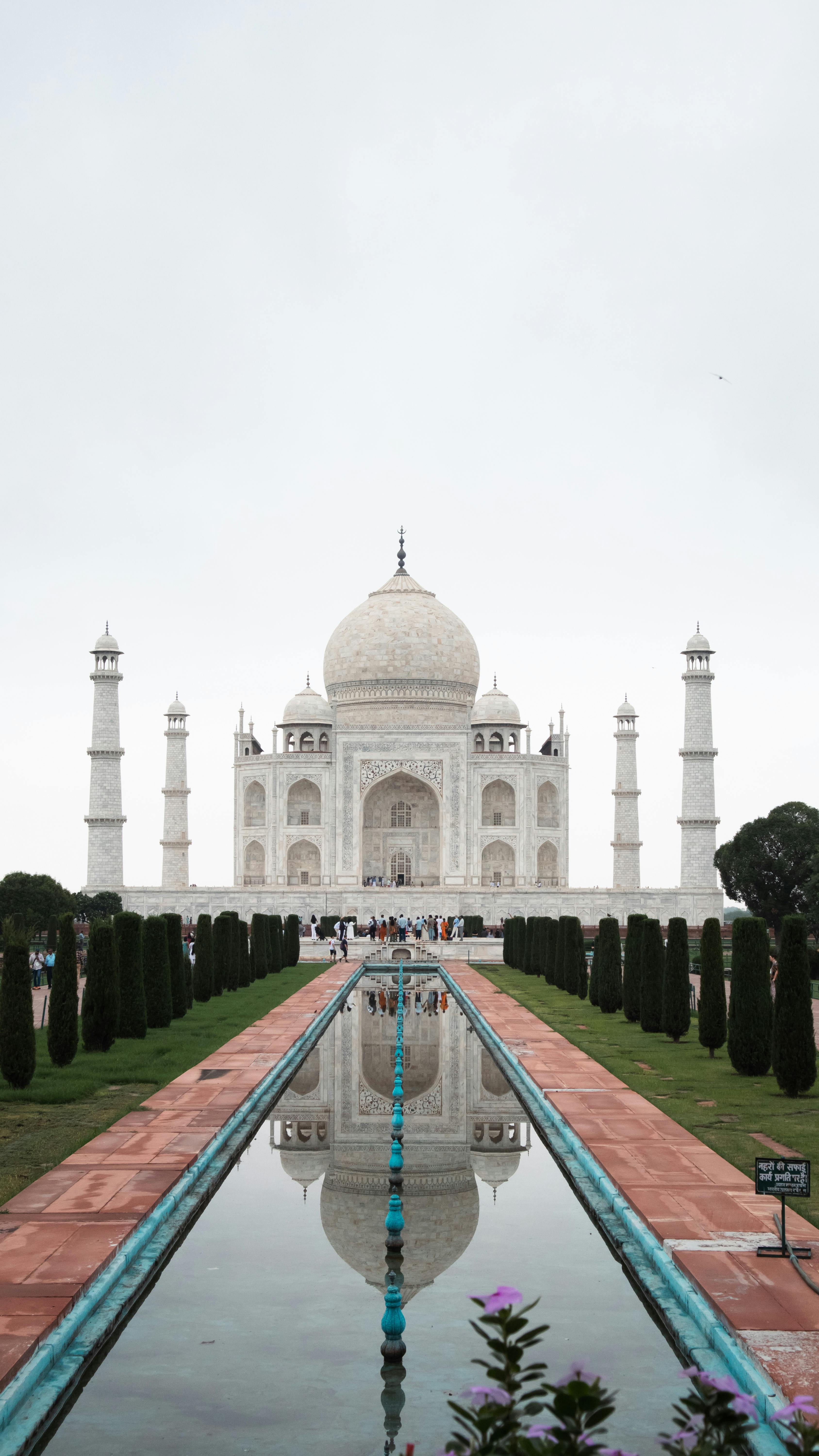 The taj mahal is a white building with a water feature · Free Stock Photo