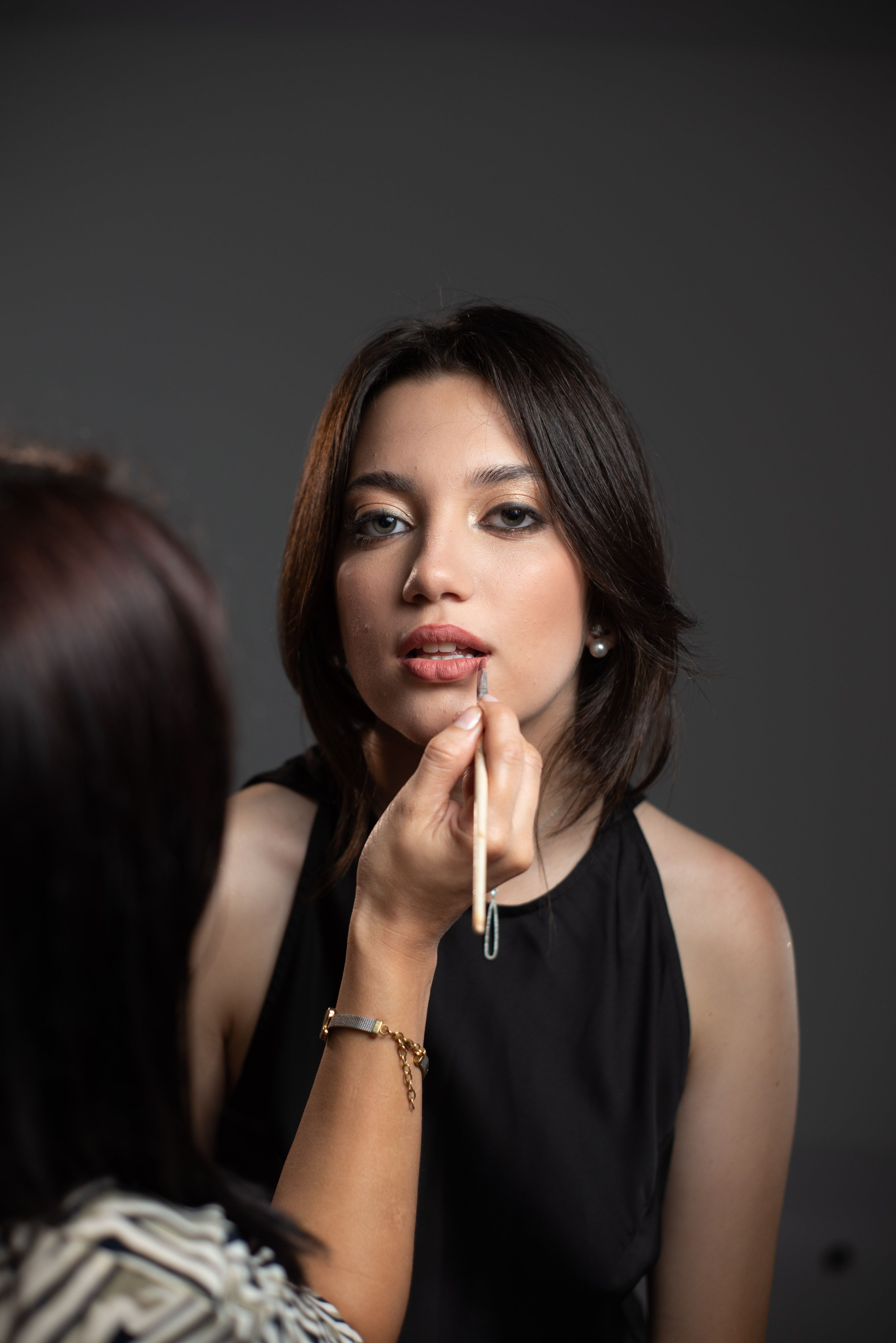 Woman Doing Make-up on a Model · Free Stock Photo