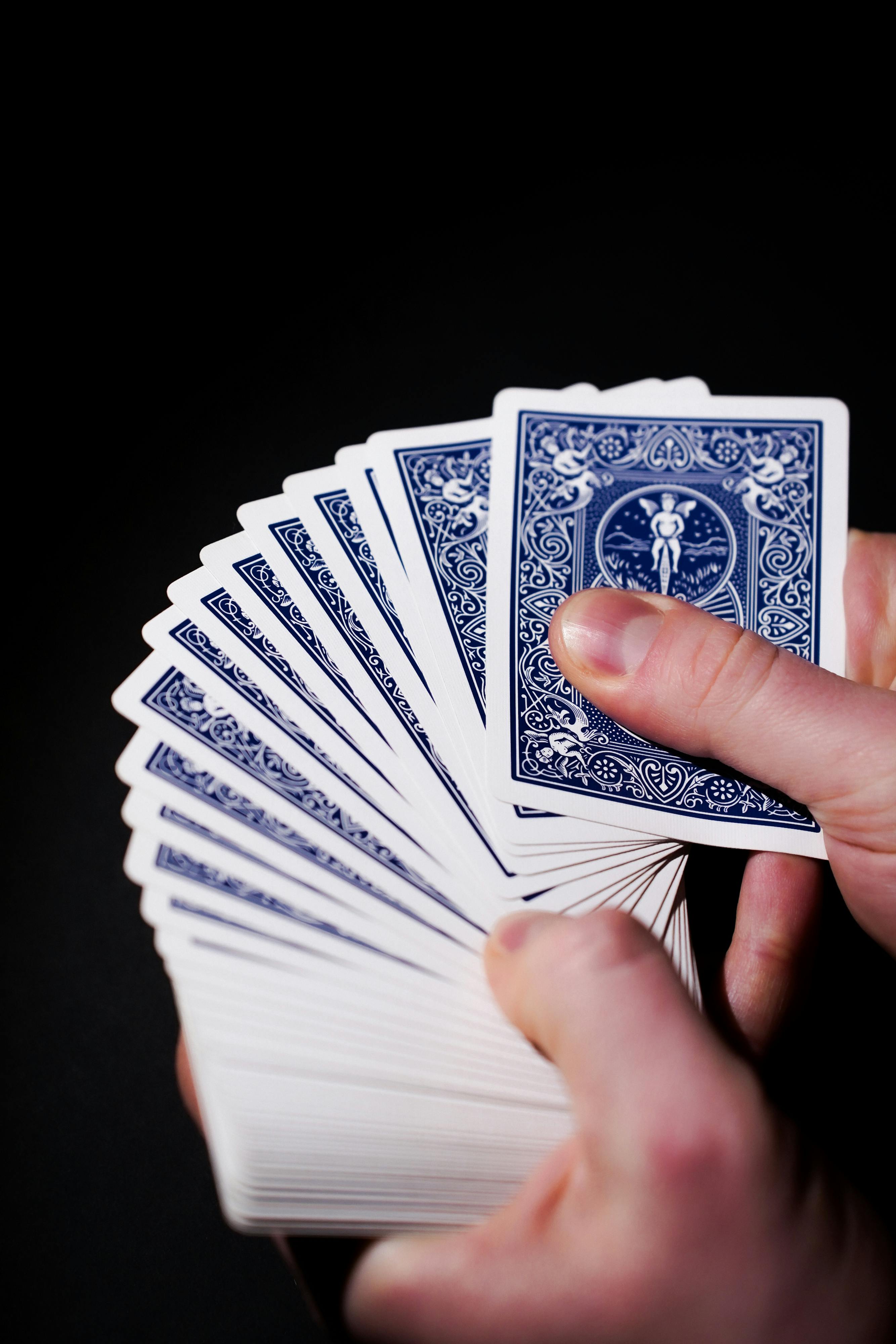 A person holding a deck of playing cards · Free Stock Photo