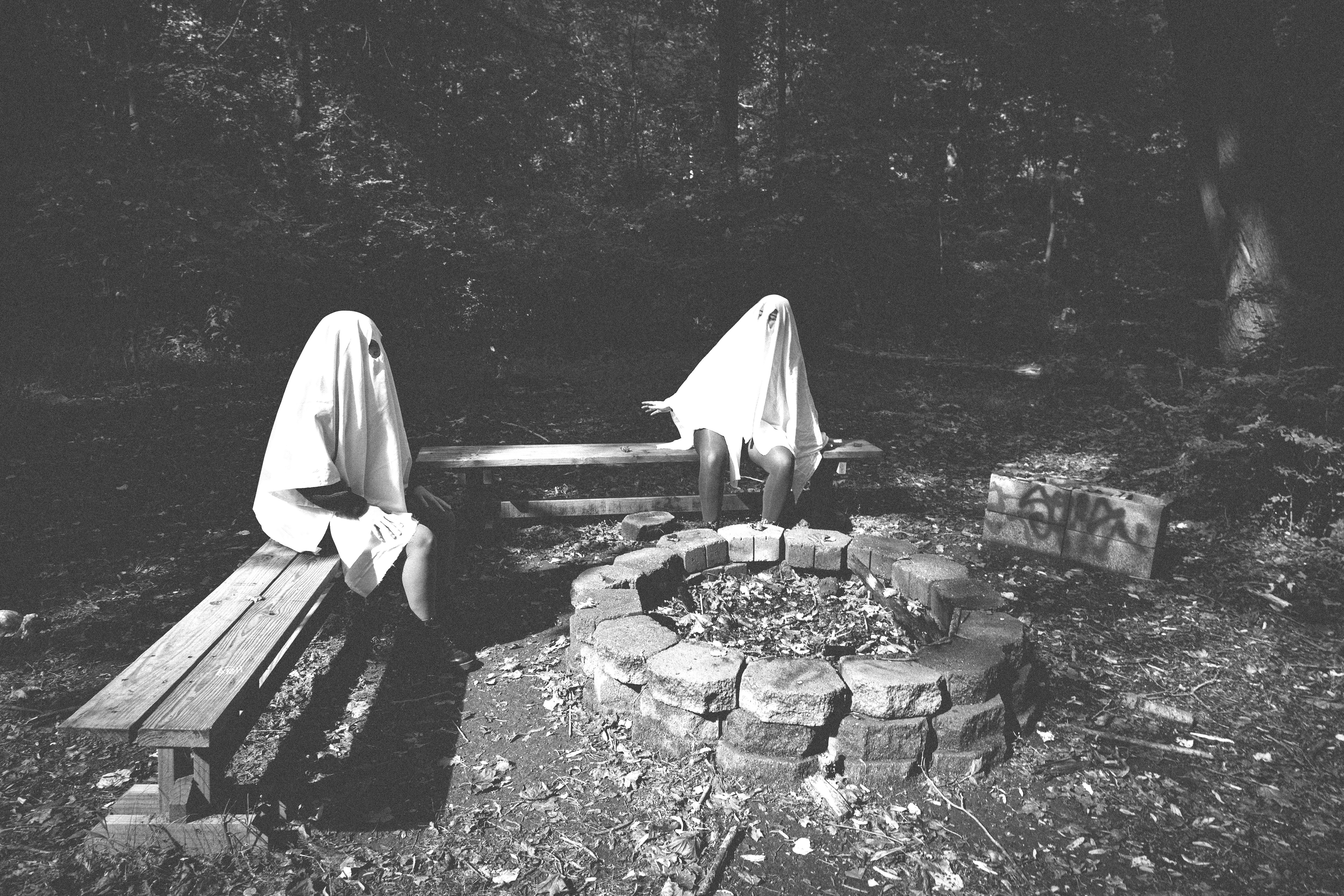 Two people in white robes sitting on a bench · Free Stock Photo