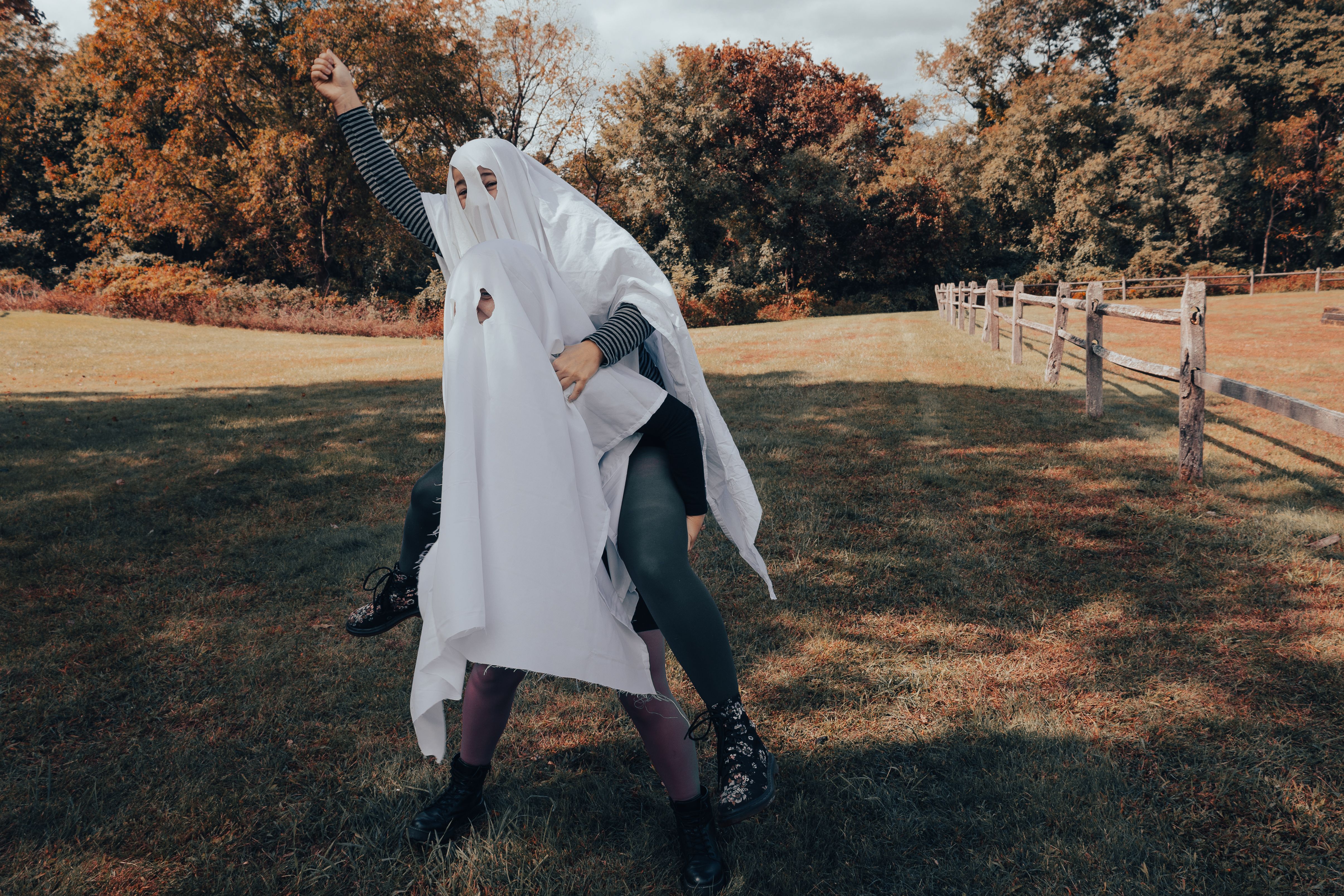 A man and woman dressed as ghosts in a field · Free Stock Photo