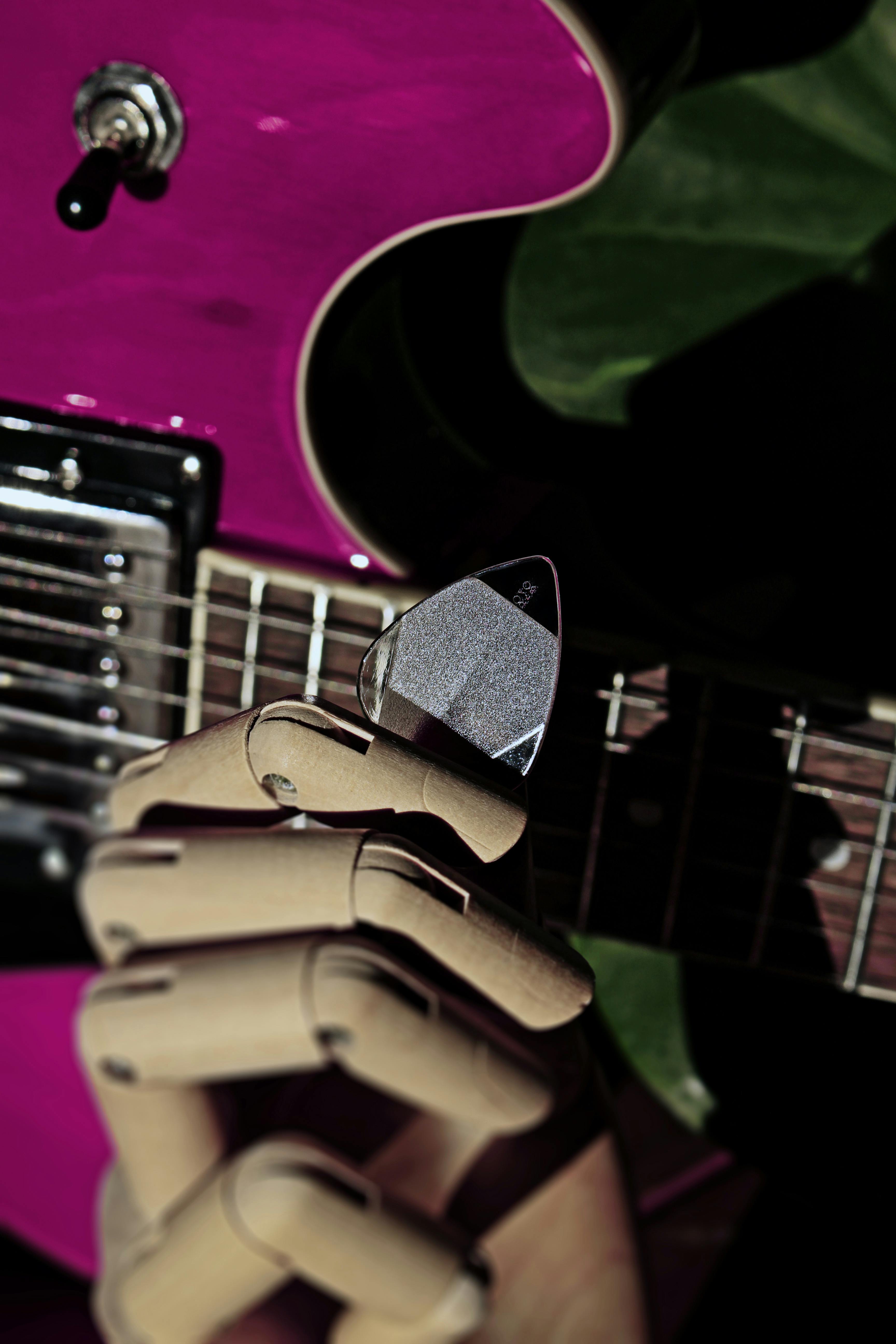 Guitar Pick in Wooden Hand · Free Stock Photo