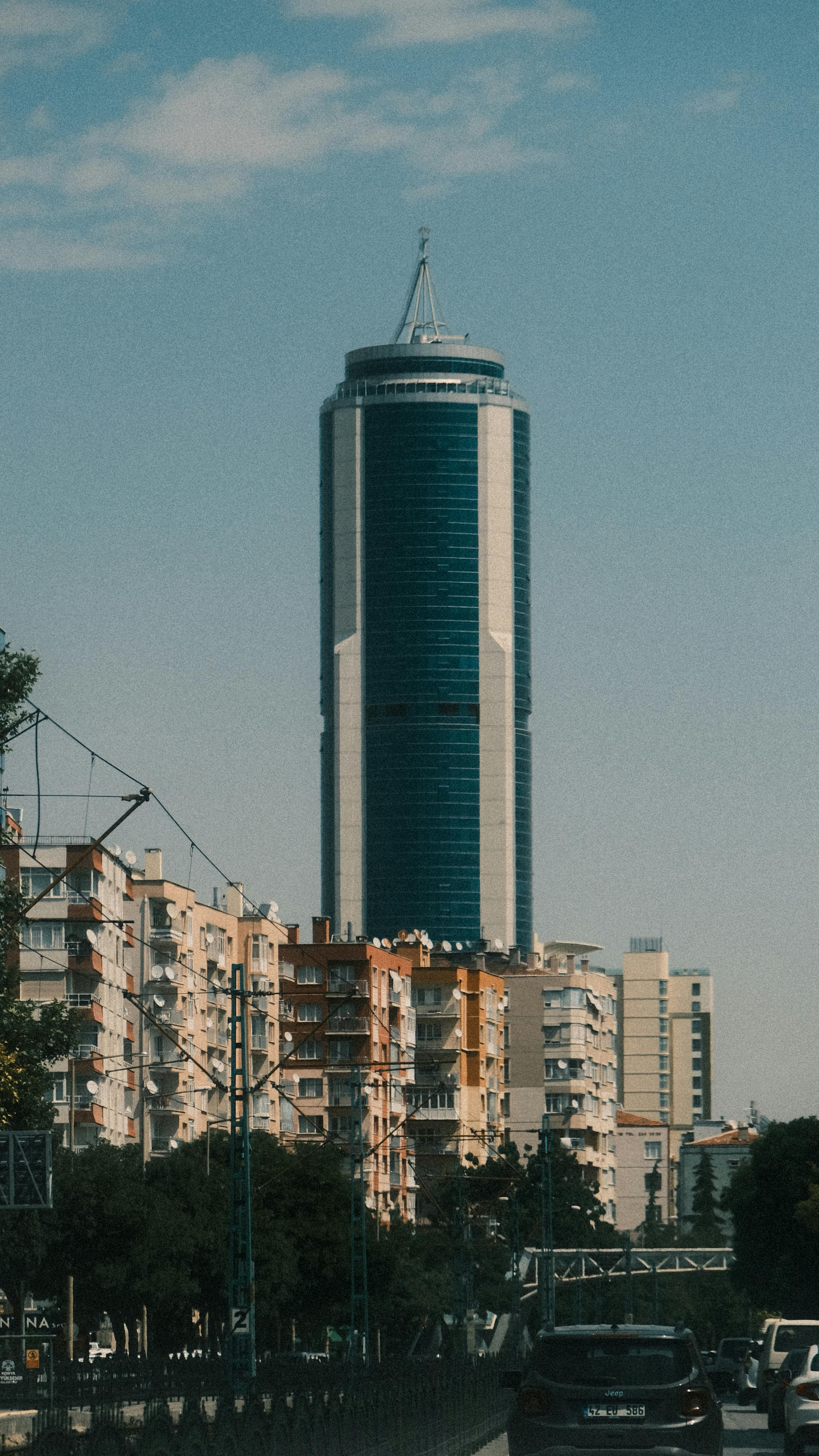 Tall Round Skyscraper between Smaller Apartment Buildings in City ...