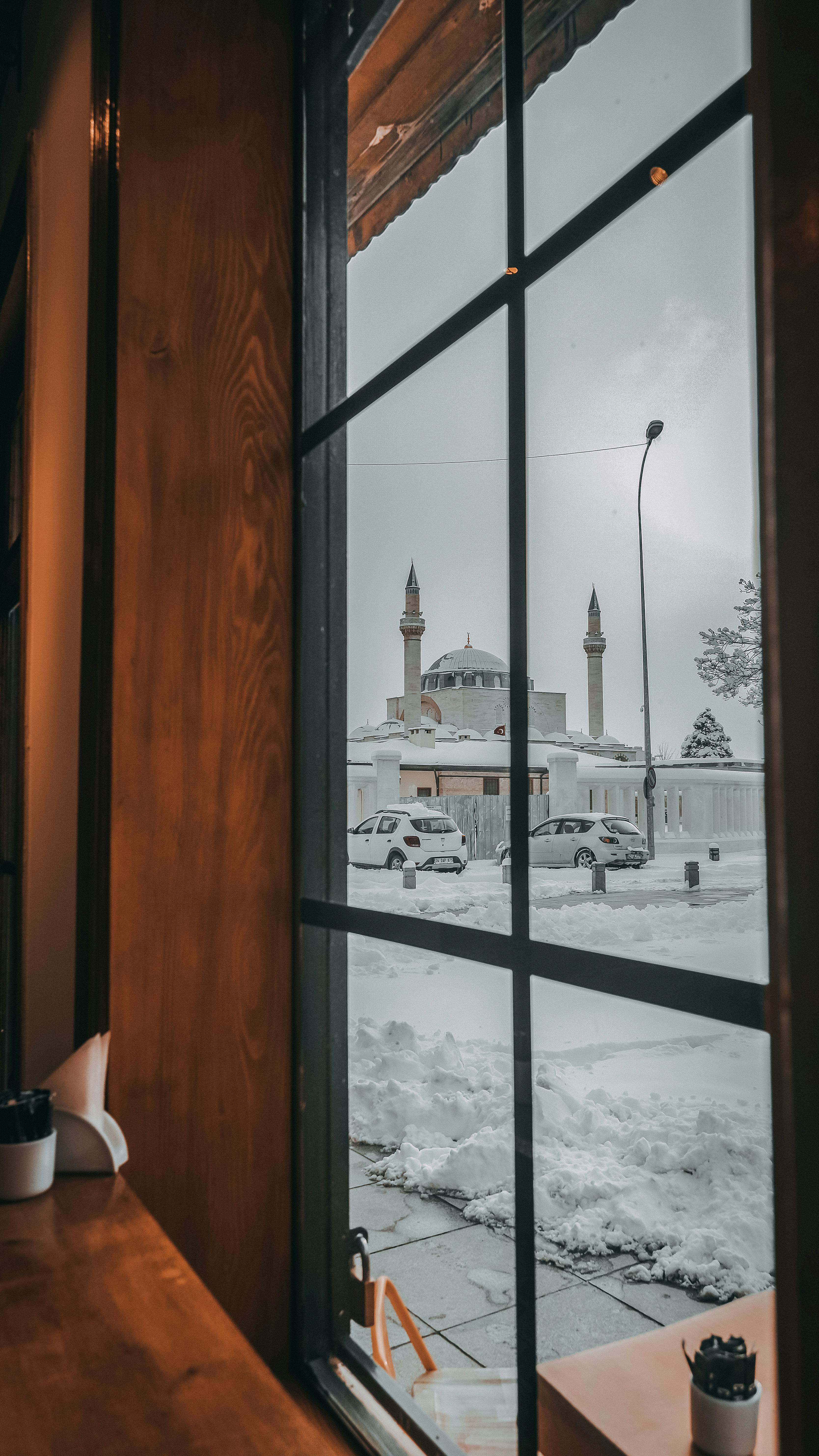 Mosque and Street in Snow behind Cafe Windows · Free Stock Photo