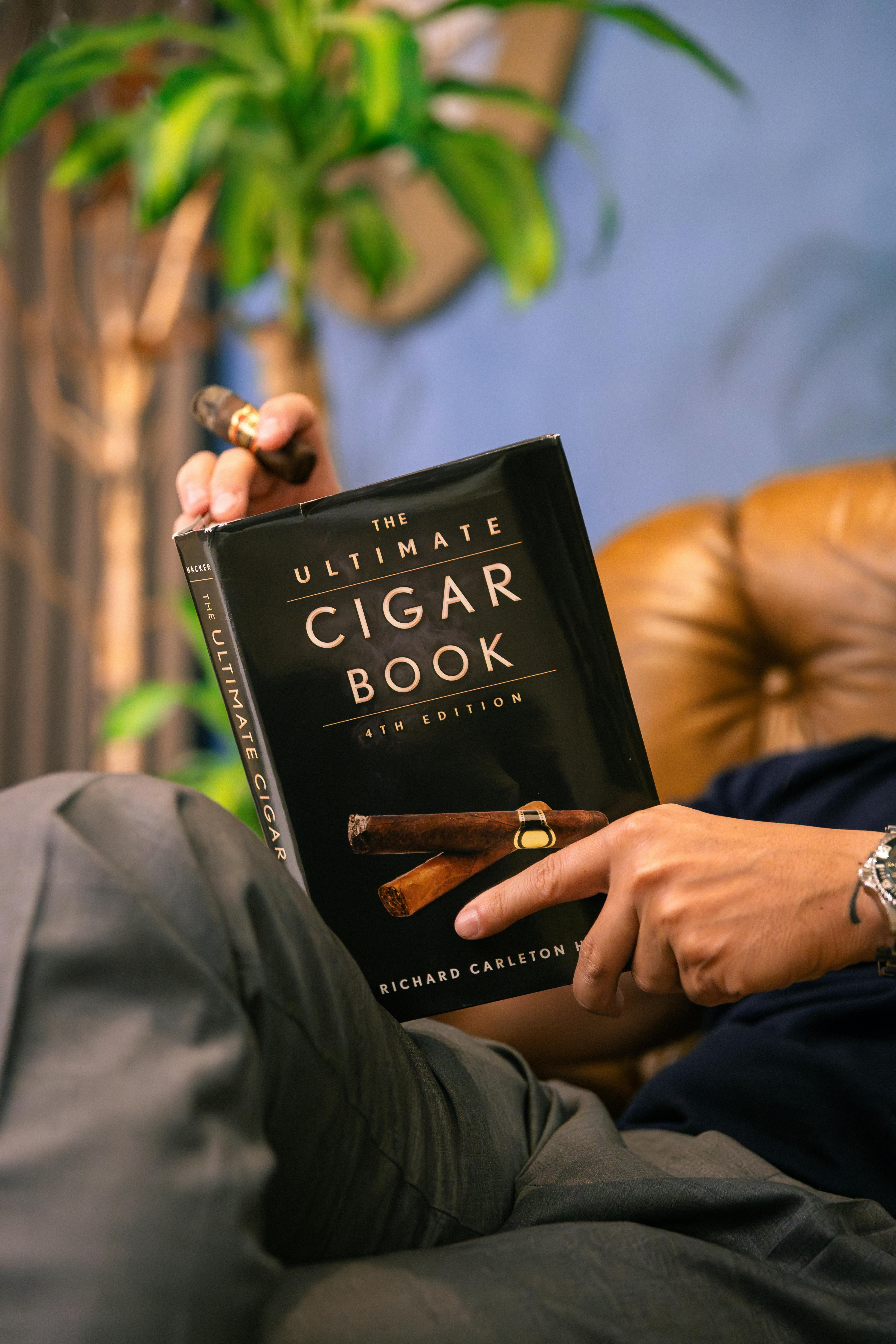 Man Reading a Book and Smoking a Cigar · Free Stock Photo