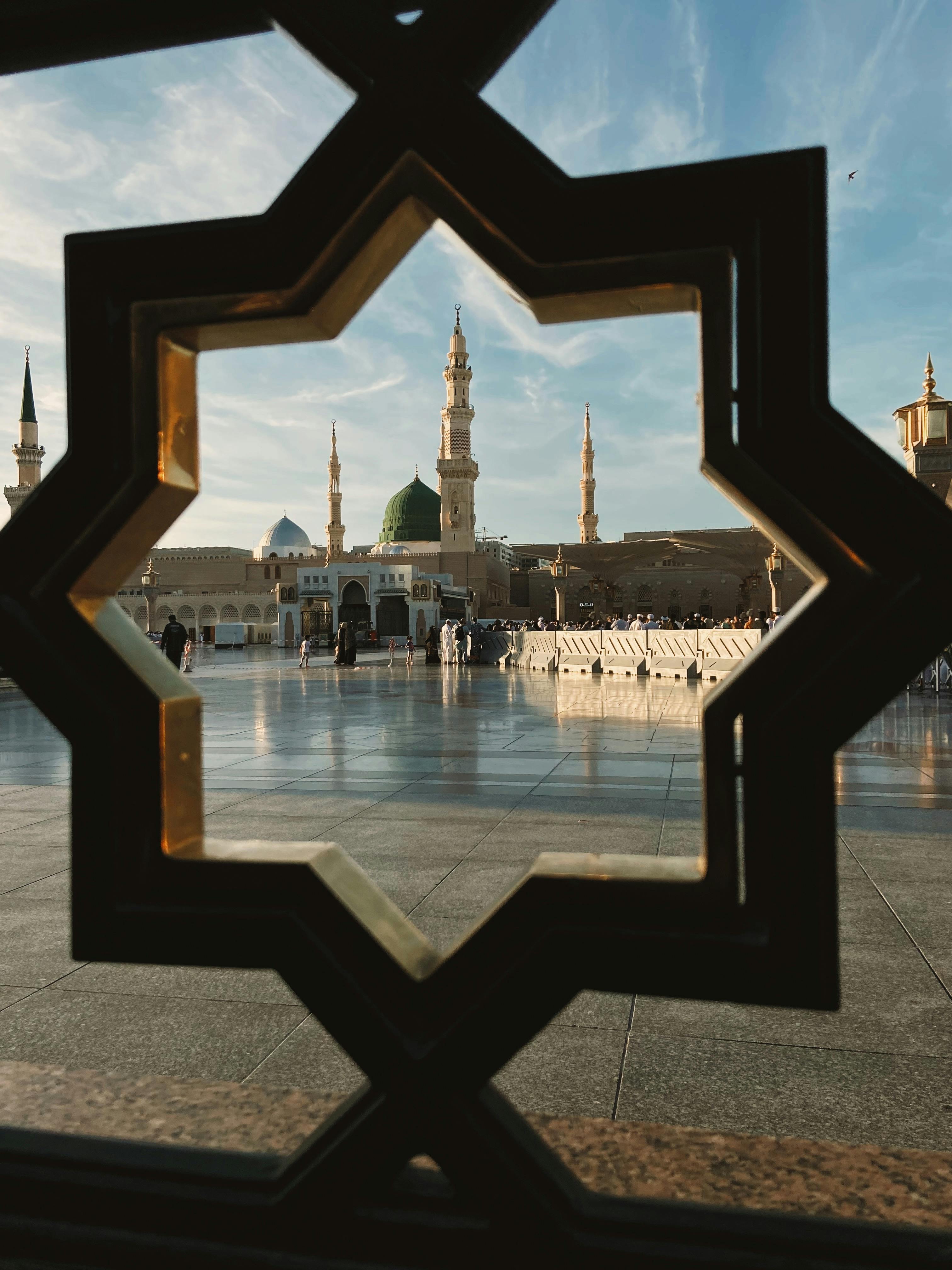 Mosque Minarets behind Window Frame · Free Stock Photo