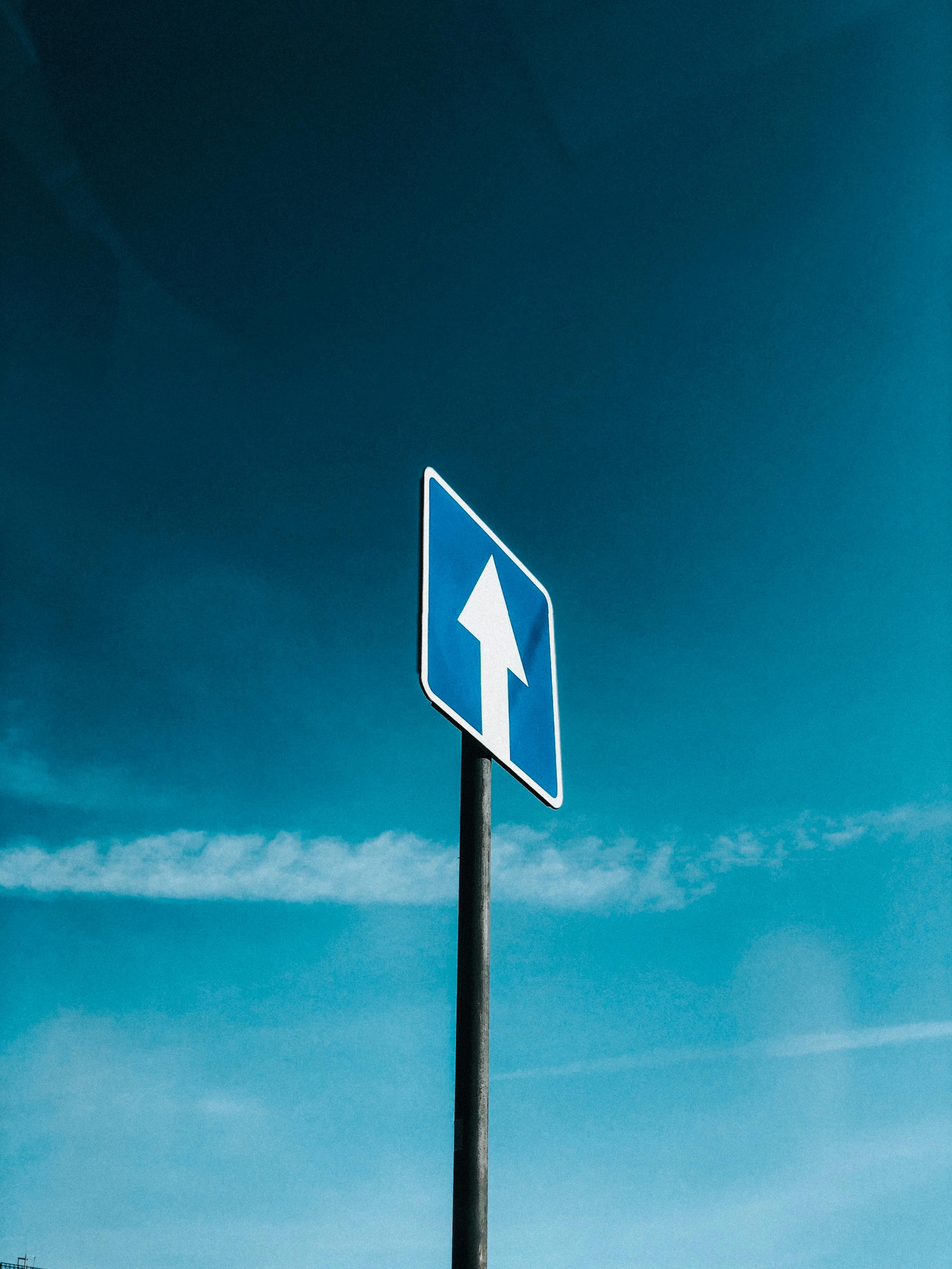 Person Standing On Arrow · Free Stock Photo