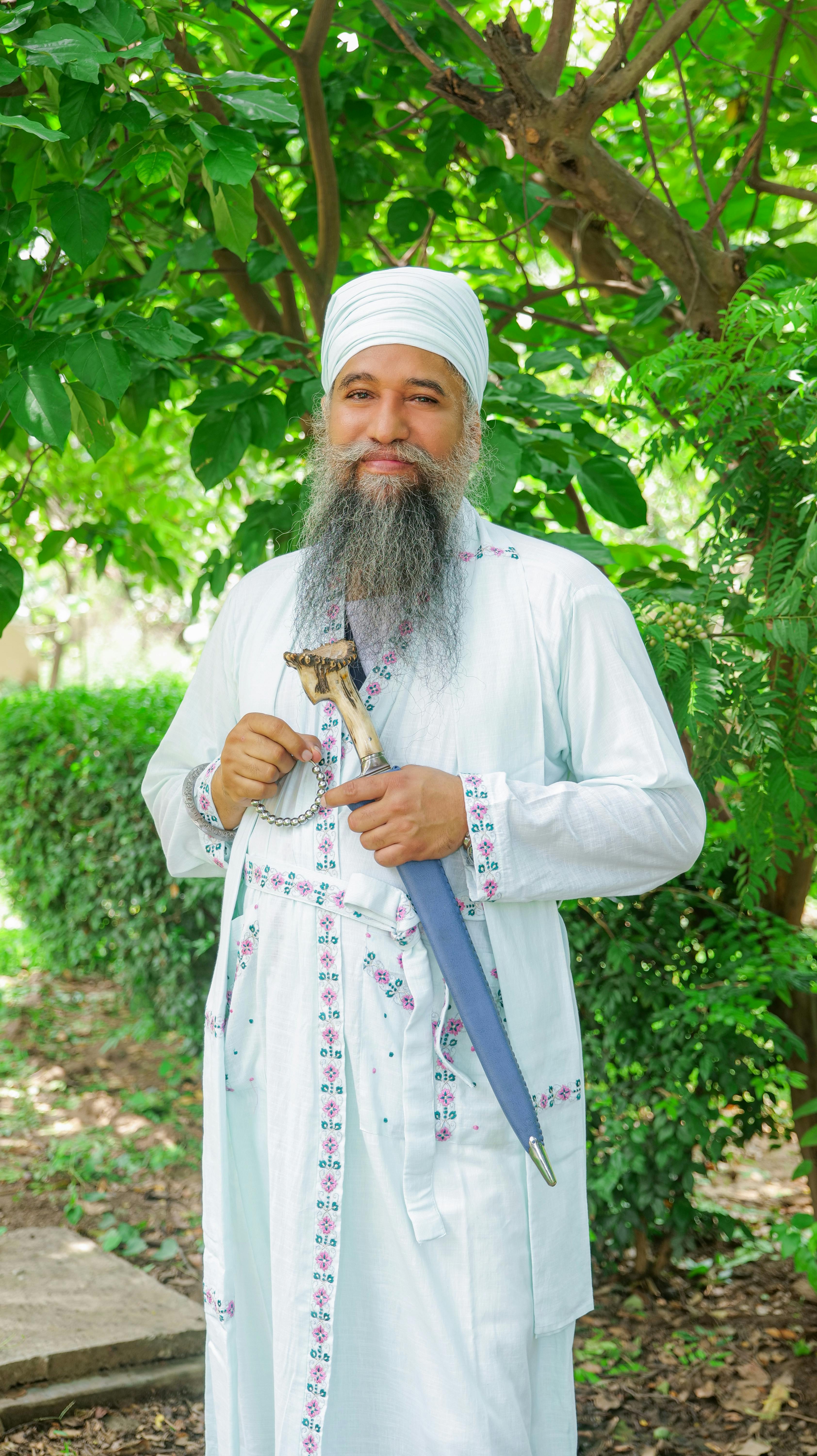 Traditionally Dressed Man Holding a Long Dagger · Free Stock Photo