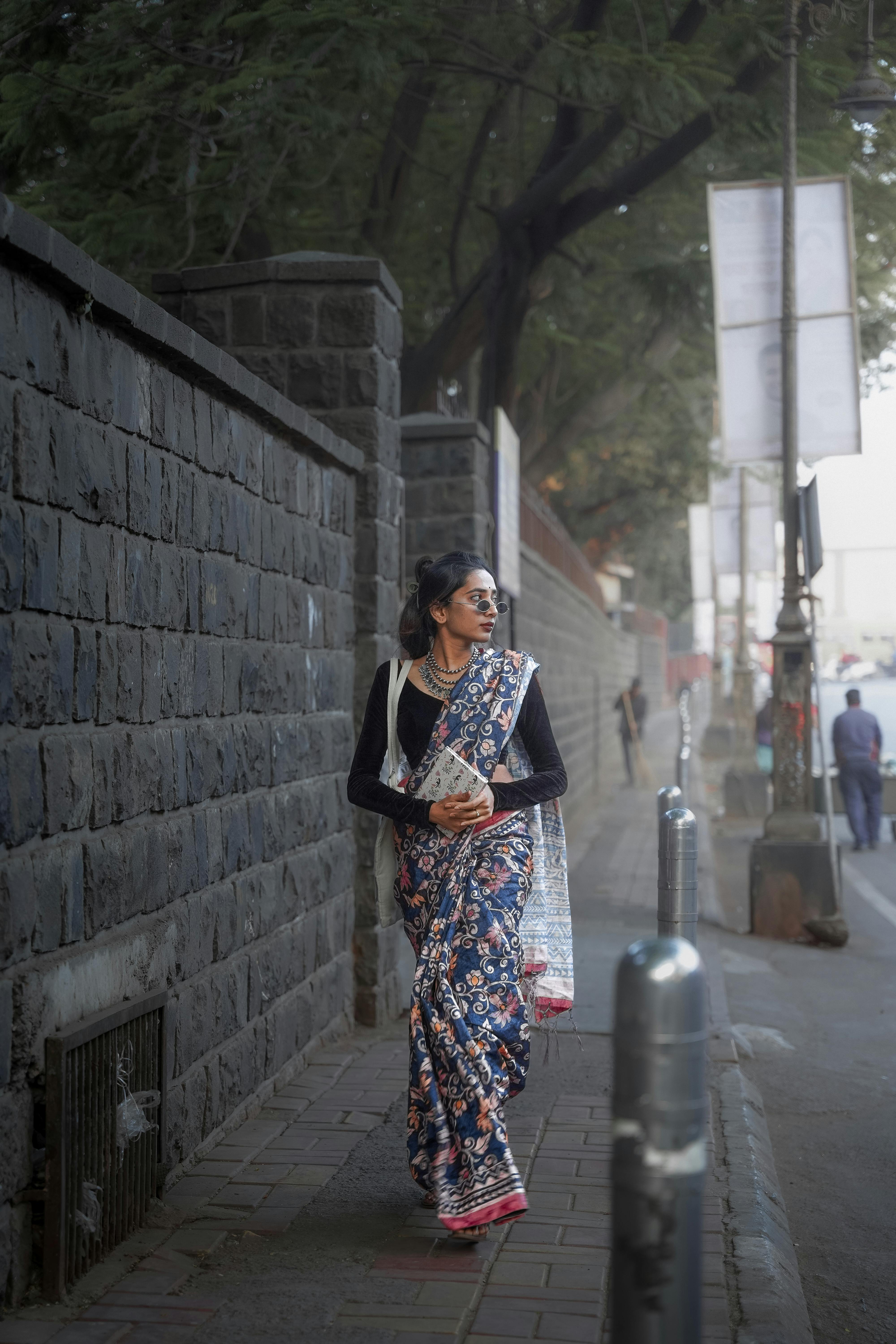 Indian Woman in Traditional Clothing Walking on a Sidewalk · Free Stock ...