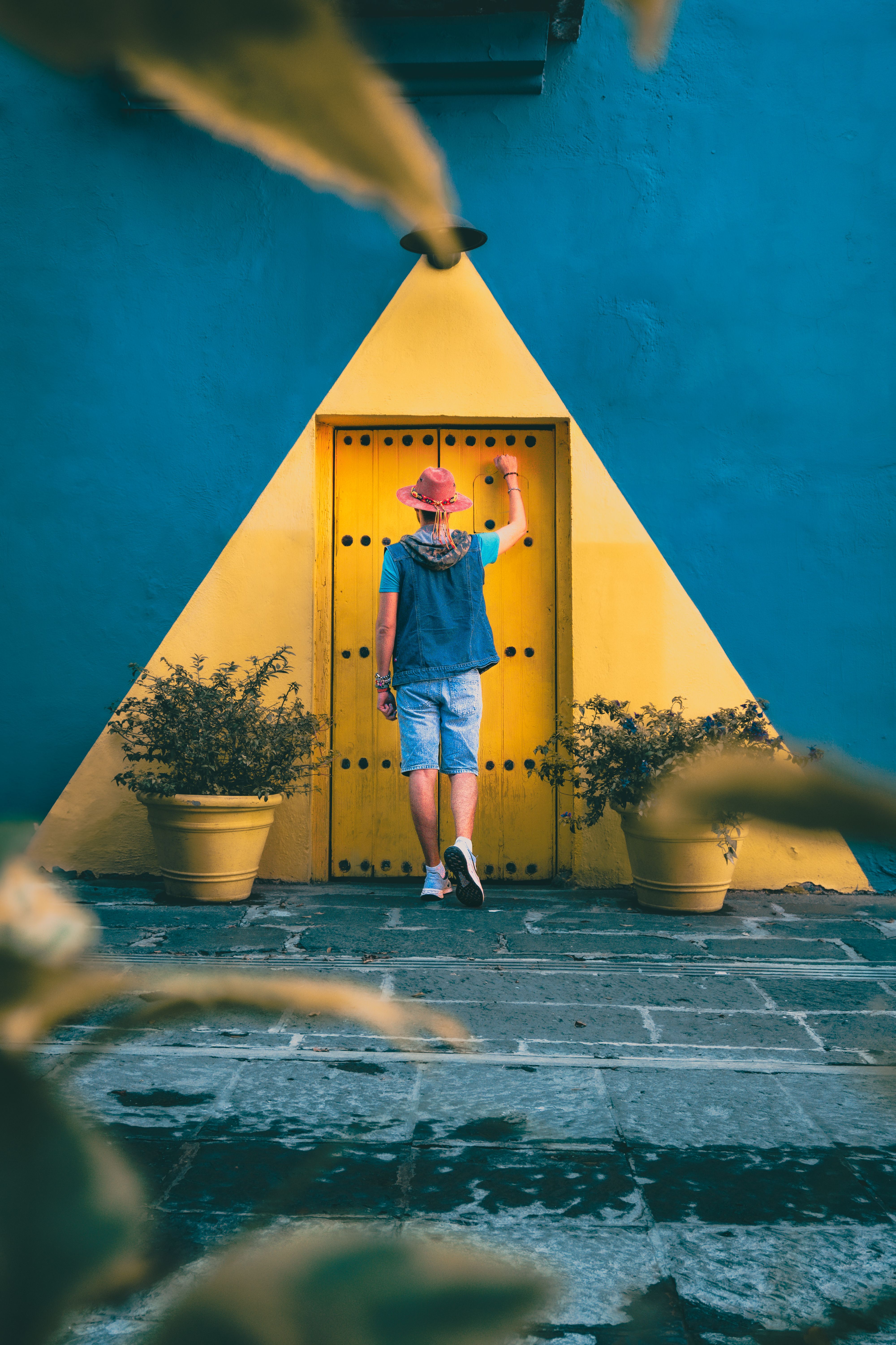 Person Knocking on the Yellow Door · Free Stock Photo