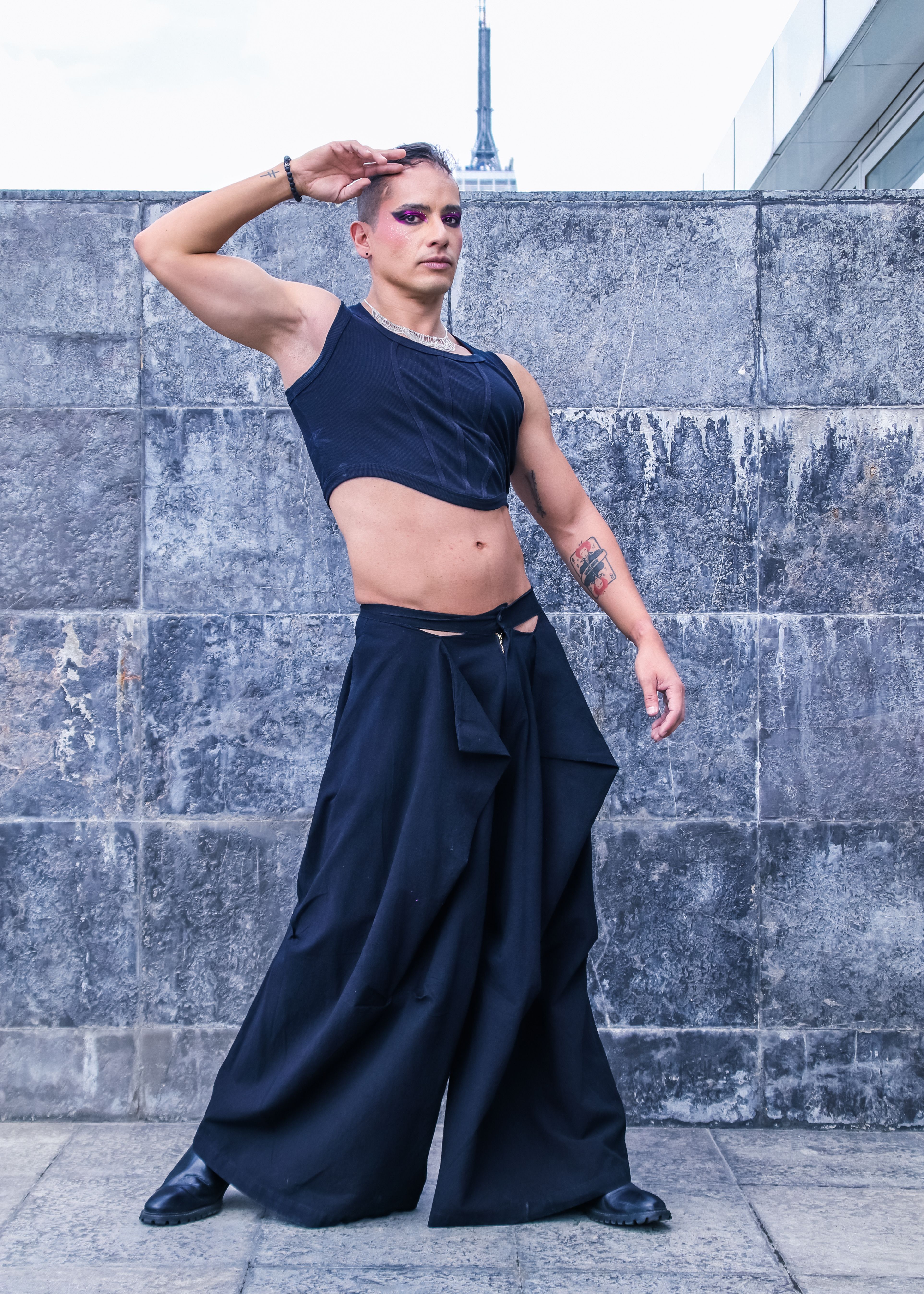 Muscular Model Posing Wearing Black Top Wide Black Pants and Artistic ...