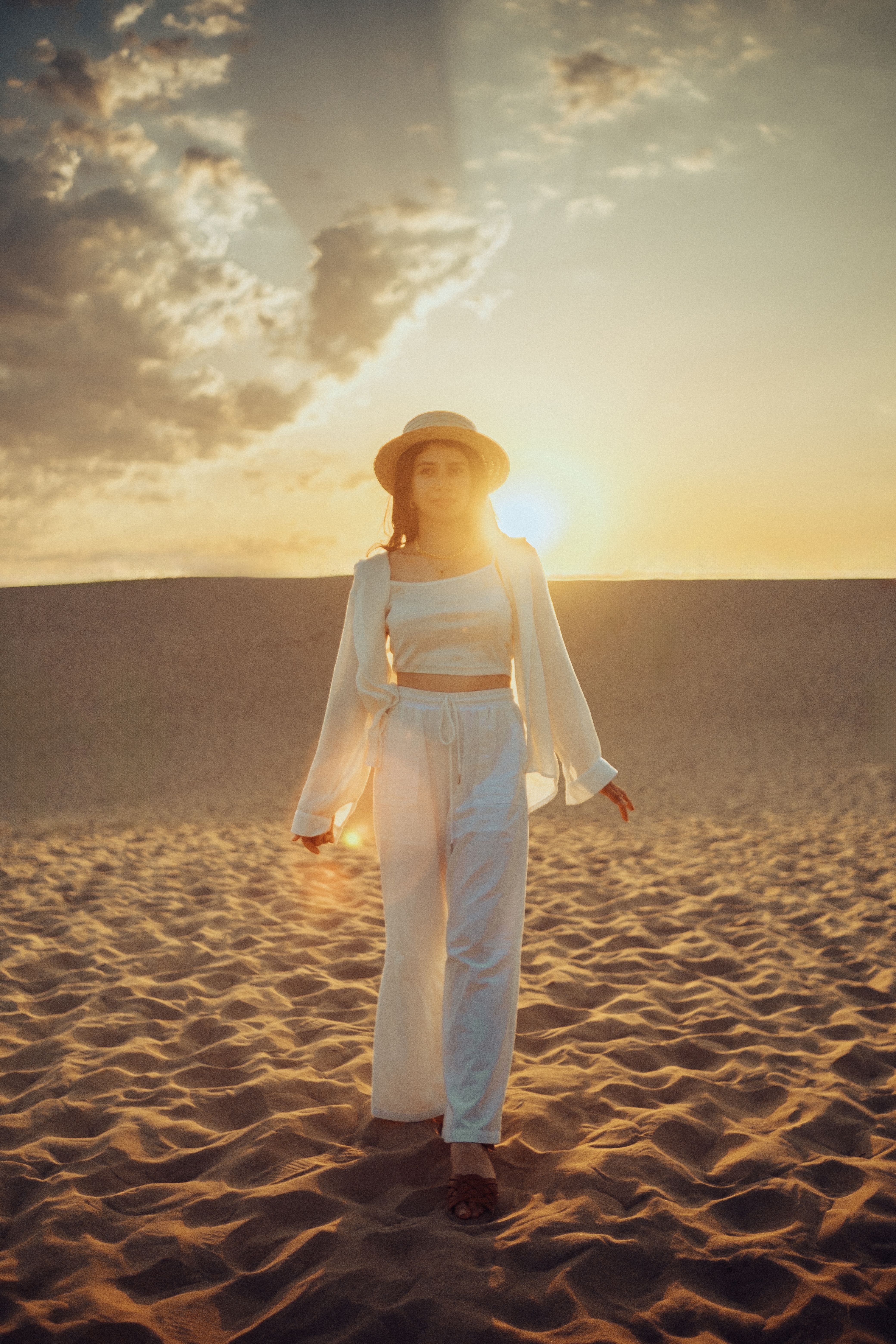 Woman in White Clothes and Hat on Desert at Sunset · Free Stock Photo