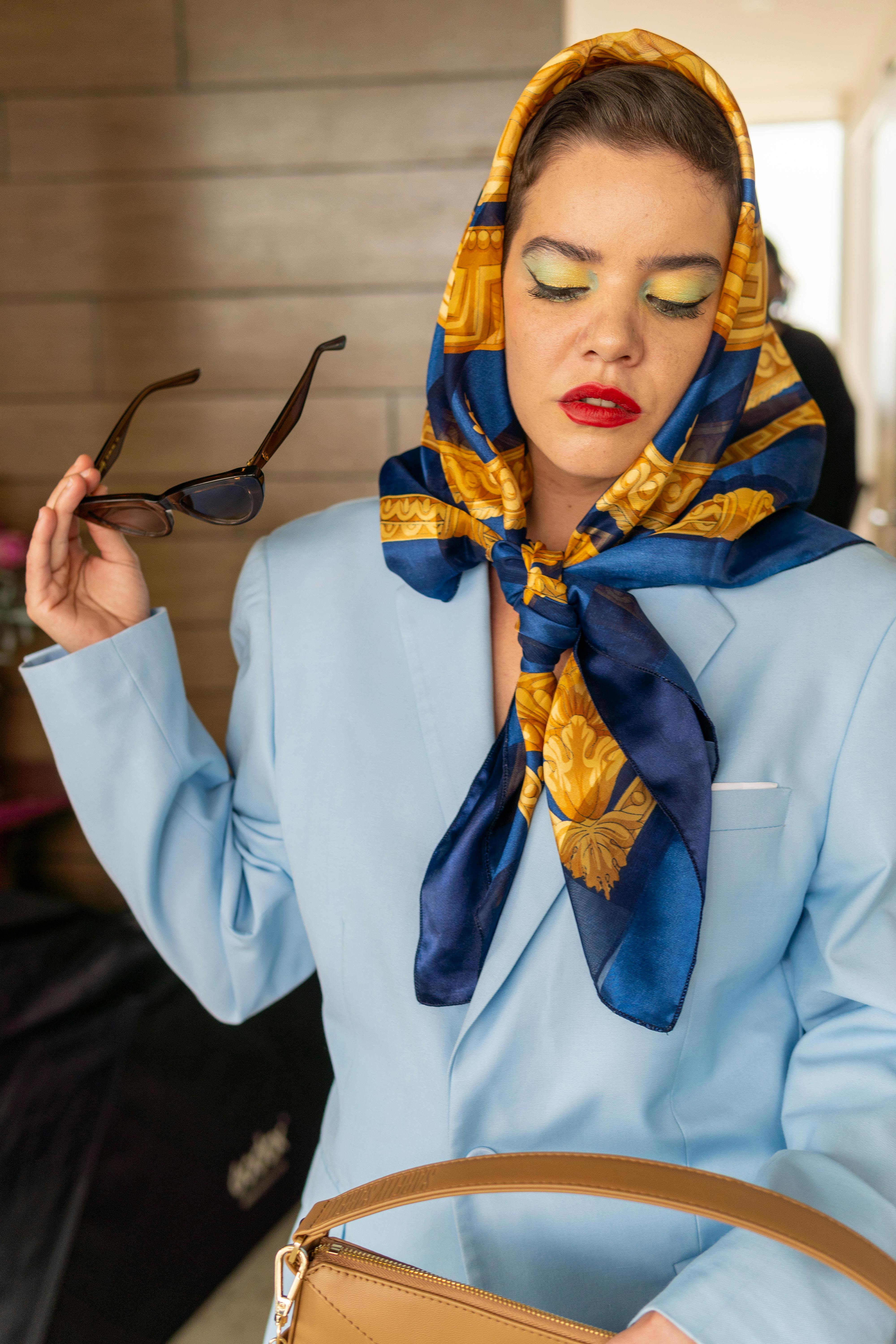 Elegant Woman Sitting Wearing Light Blue Suit Headscarf Sunglasses And Black Heels · Free Stock