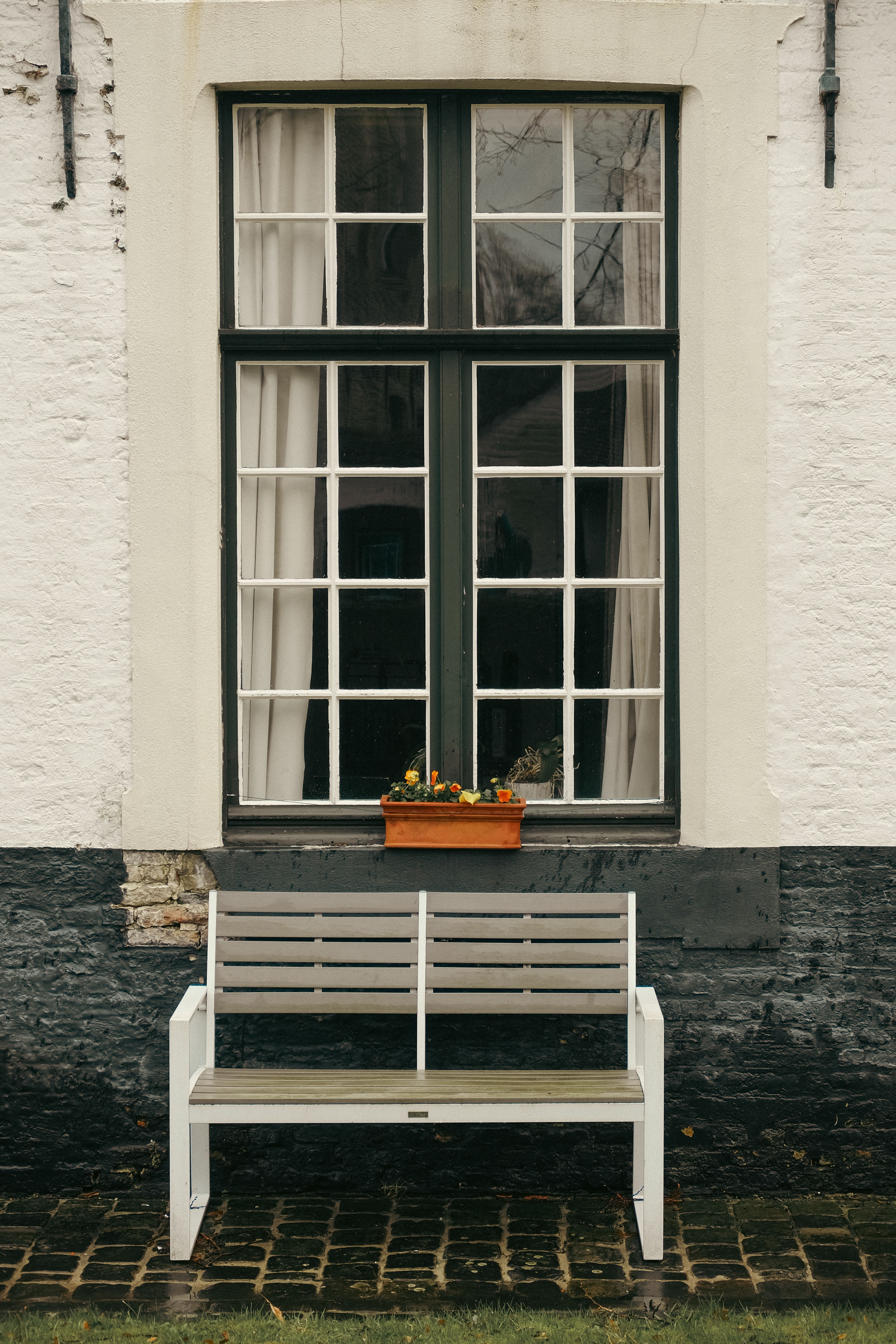 Wooden Bench in Front of a Window · Free Stock Photo