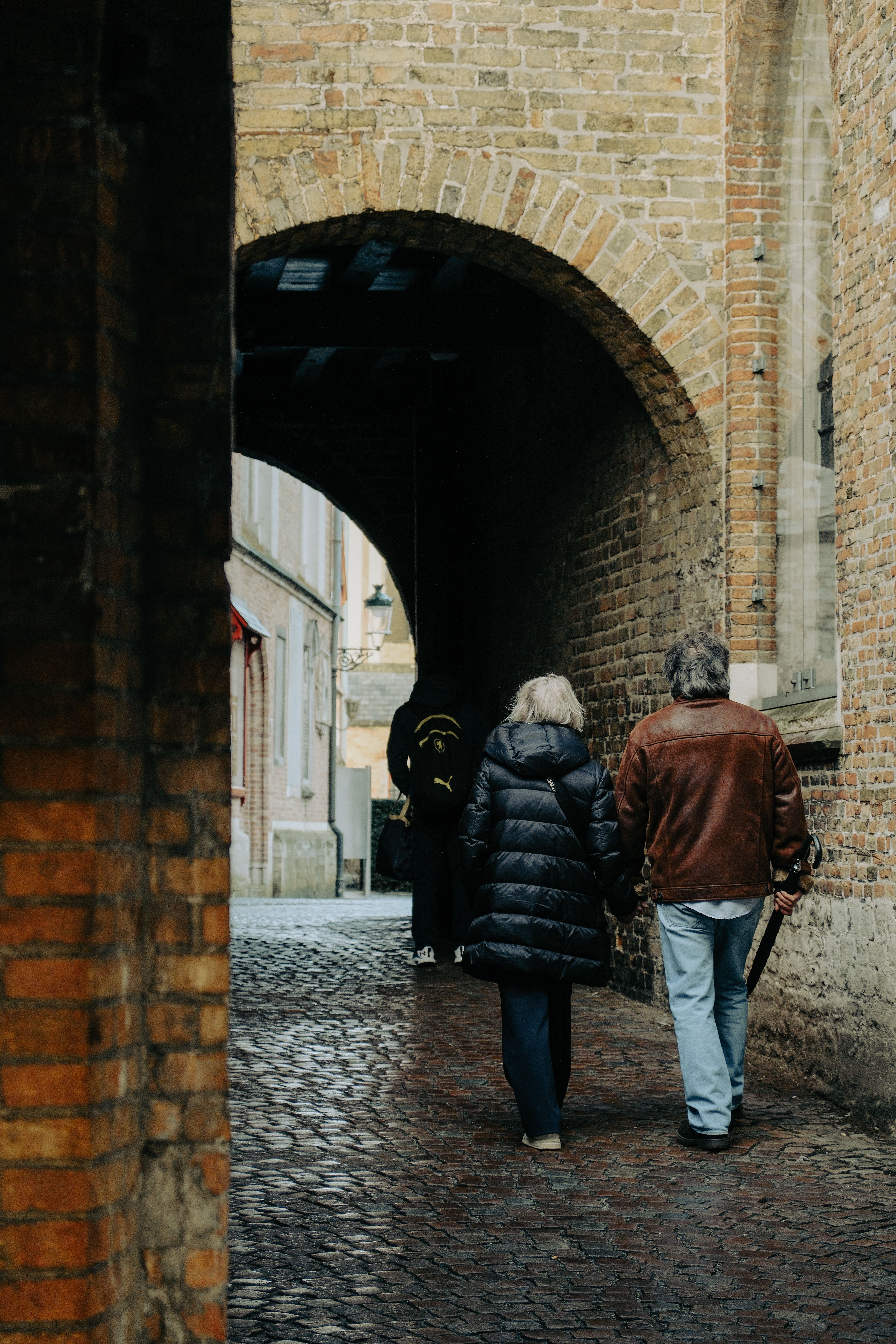 A couple walking down a brick walkway · Free Stock Photo