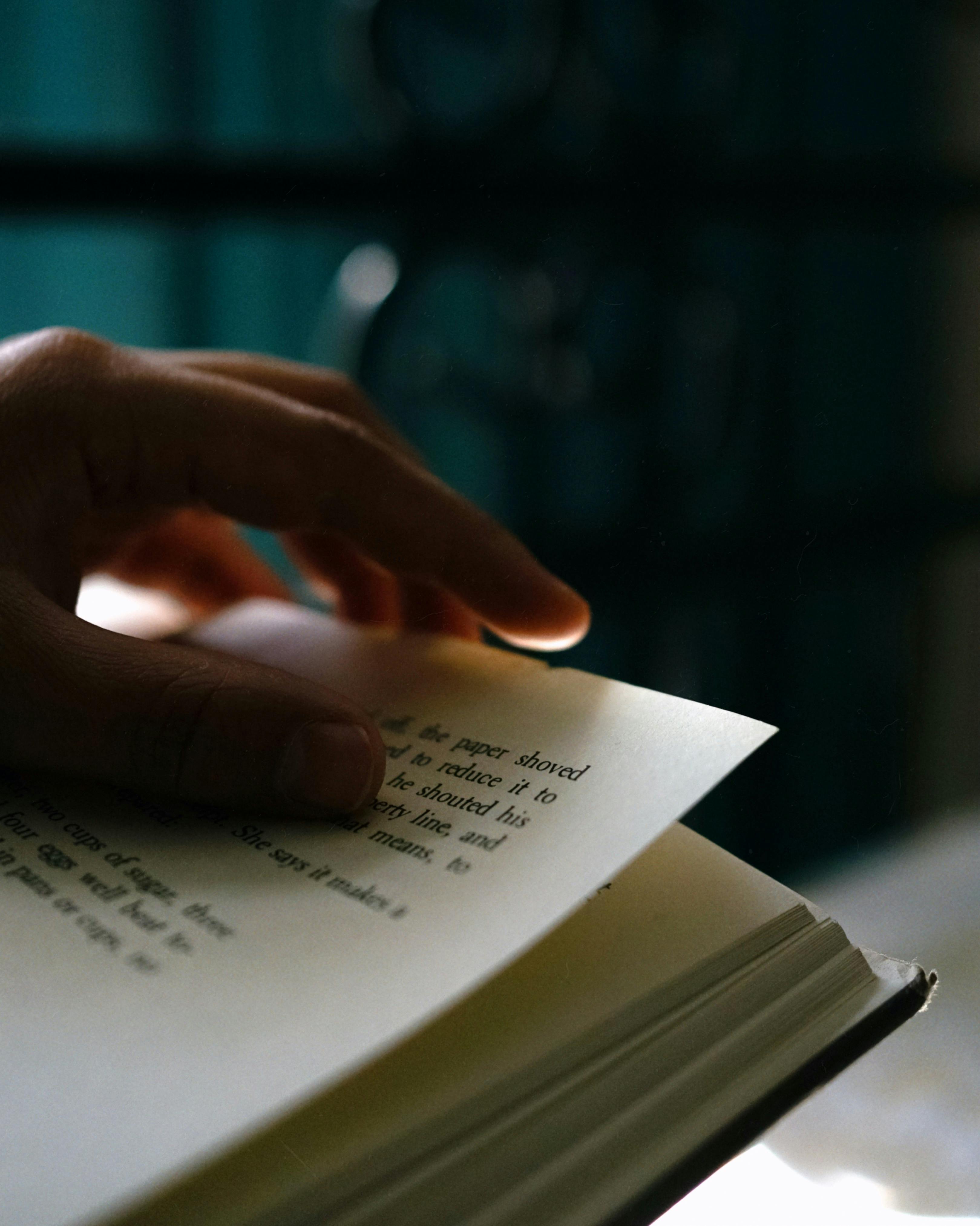 A Person Flipping Pages of a Book · Free Stock Photo