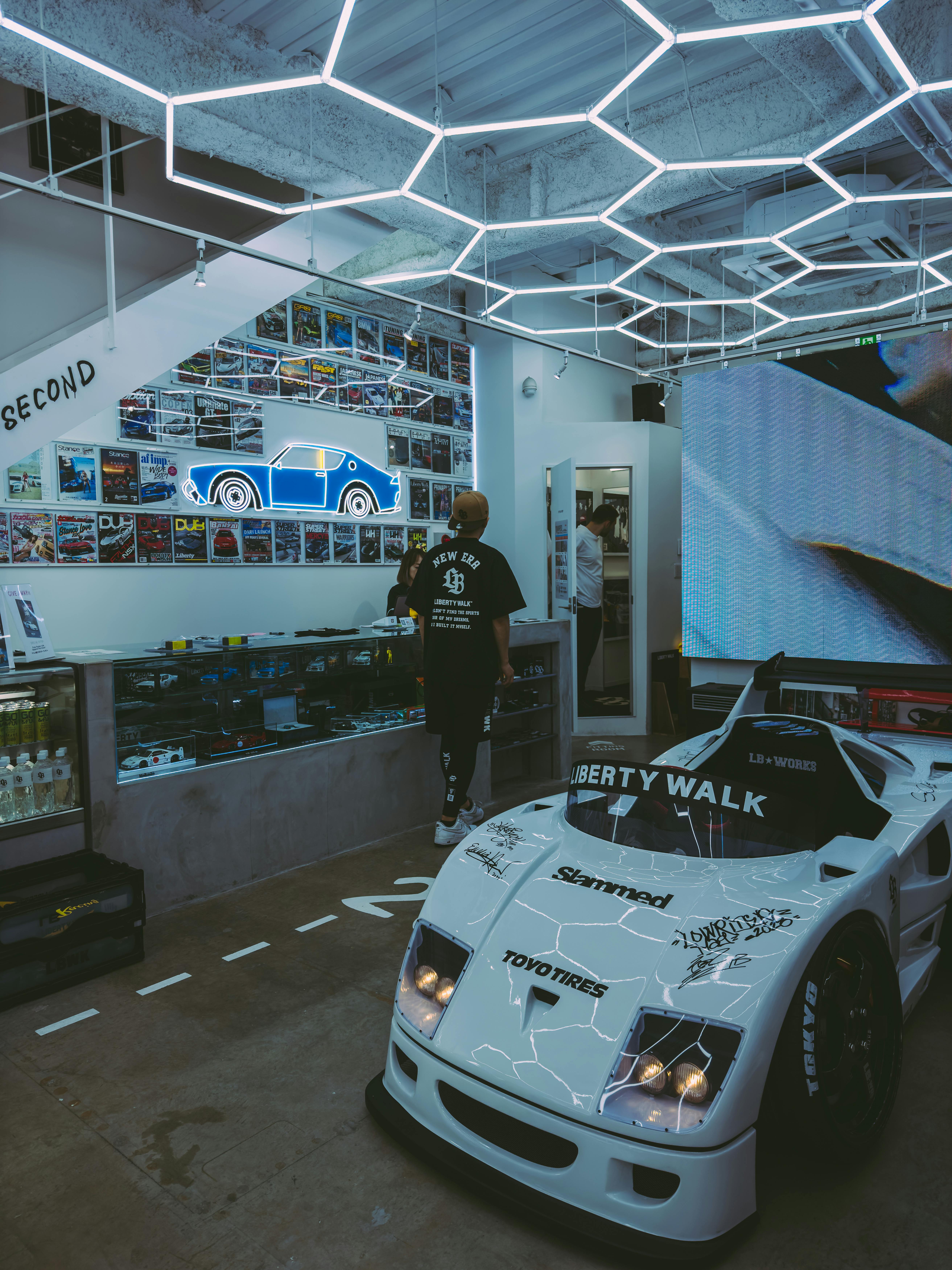 Small One Person Rally Car in Workshop Reception · Free Stock Photo