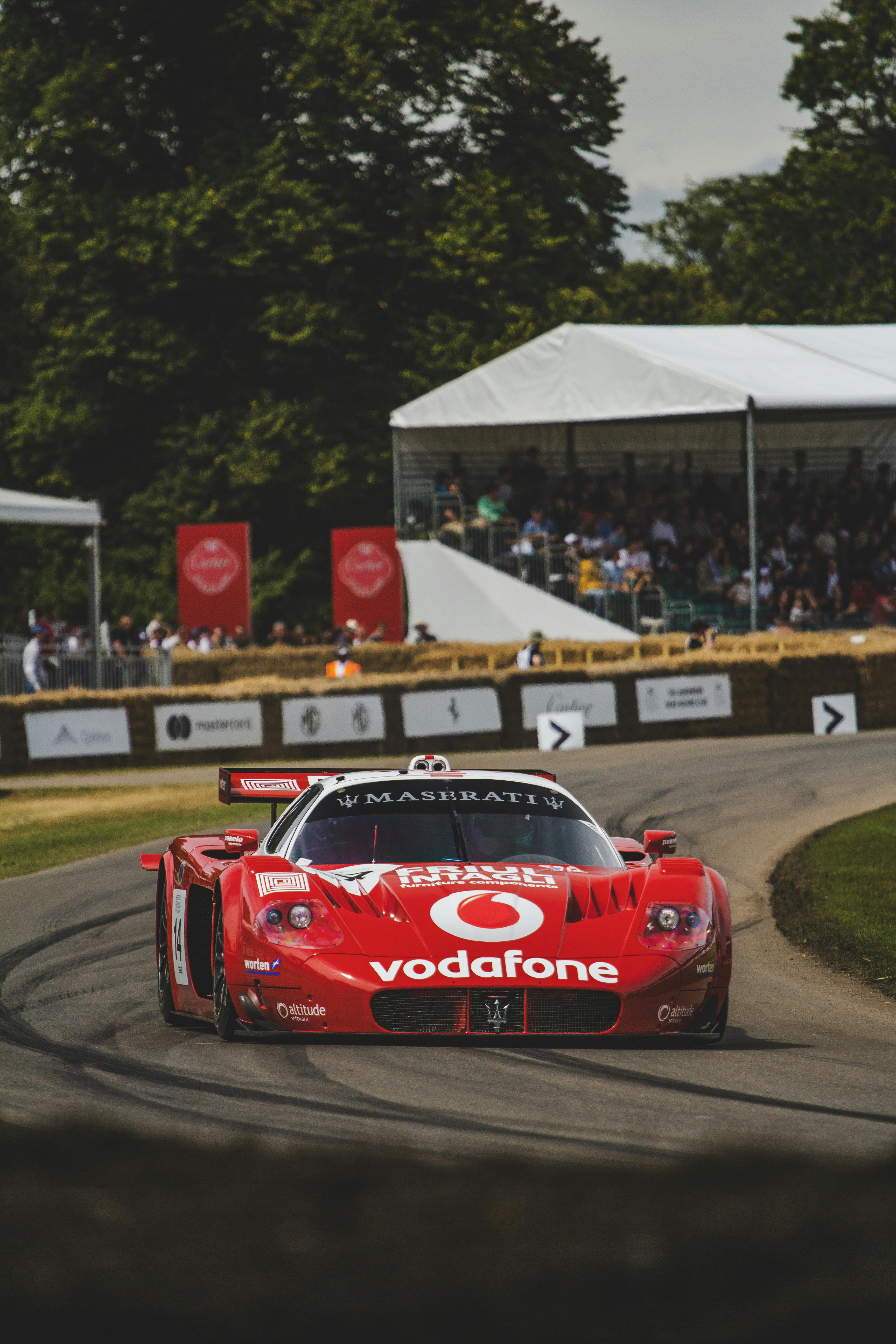 Red Racing Car on Race Track during Daytime · Free Stock Photo