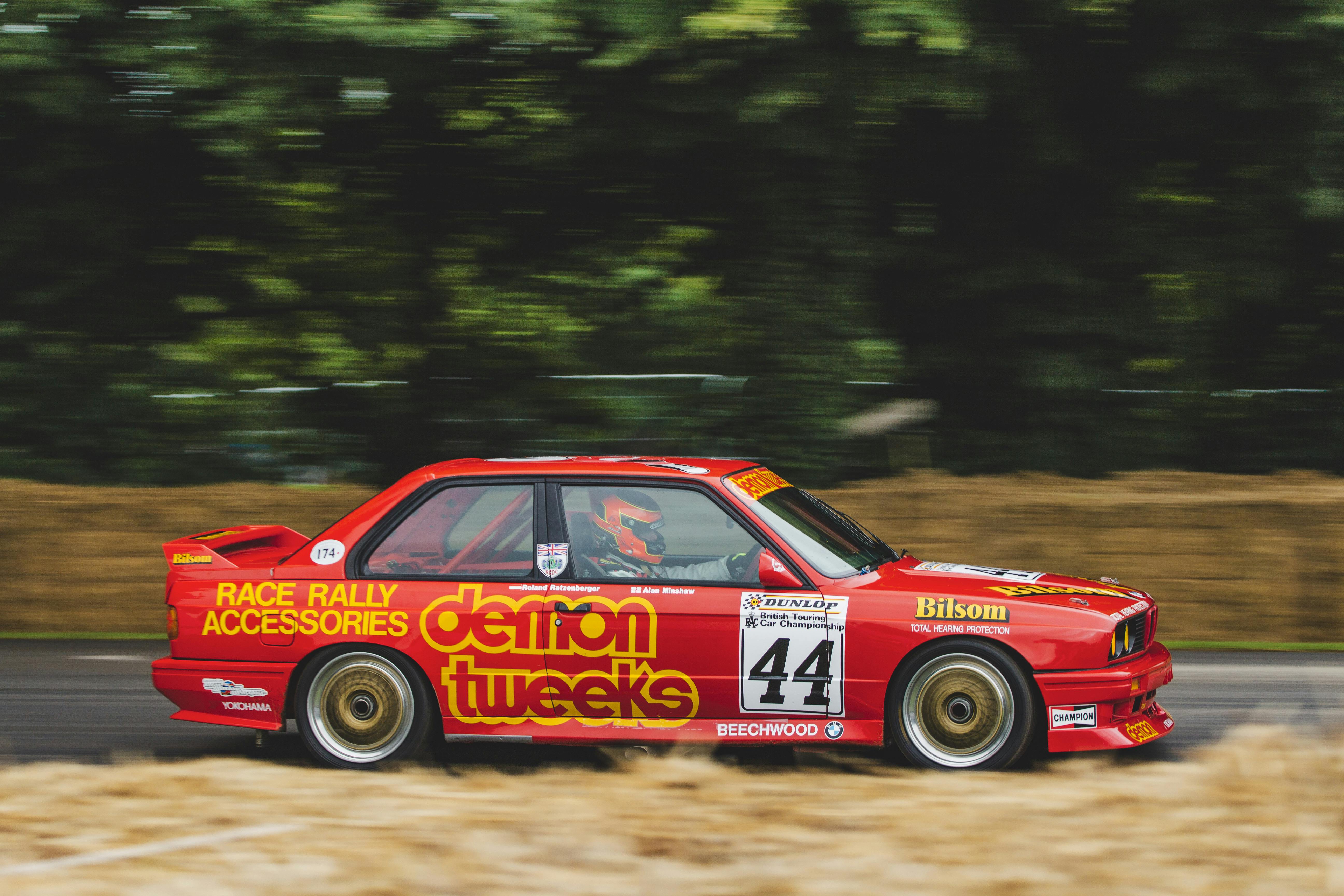 Red Racing Car on Race Track during Daytime · Free Stock Photo